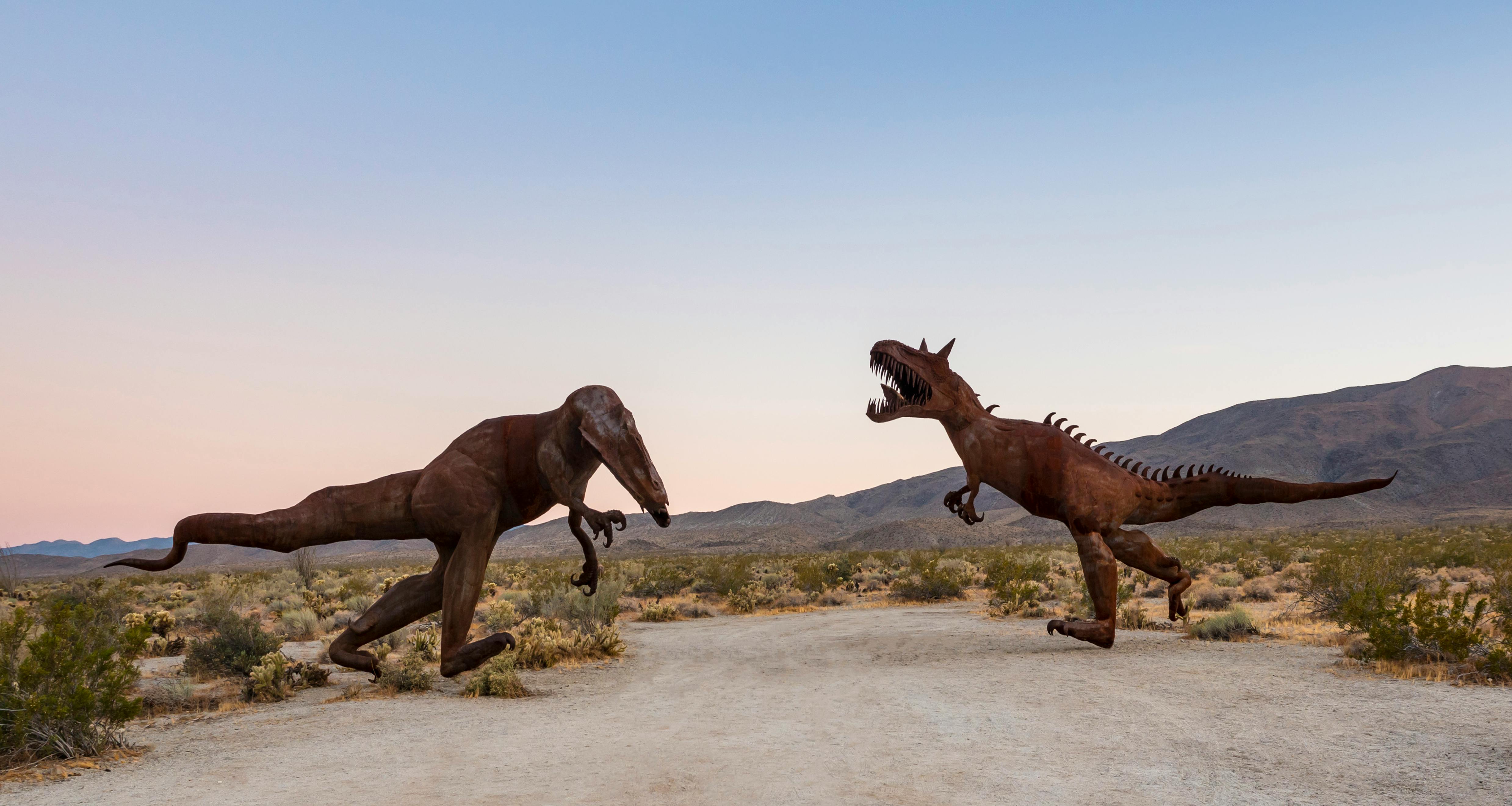 Dinosaur Sculptures in Desert Landscape · Free Stock Photo