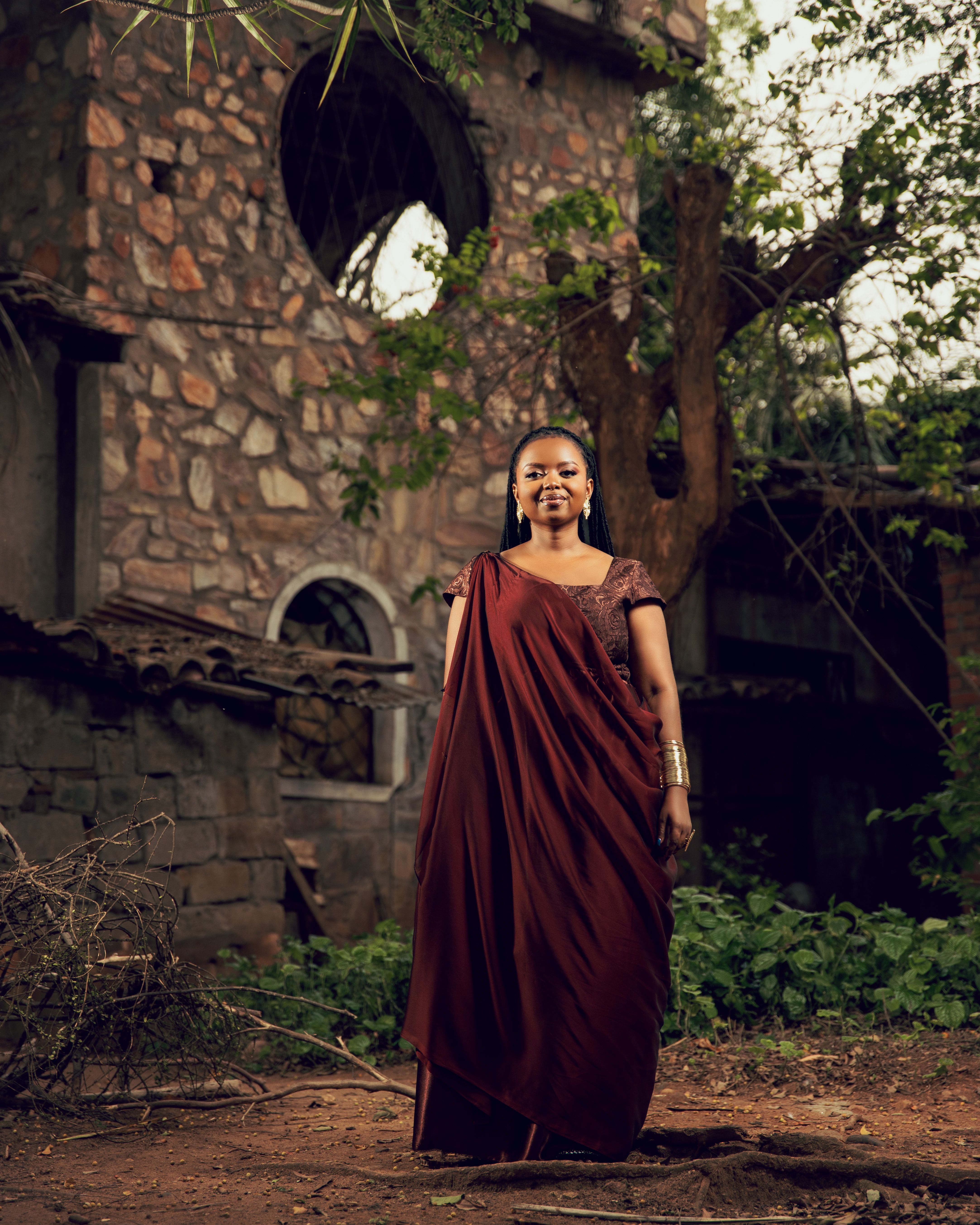 Elegant Woman in Traditional Outfit by Rustic Building · Free Stock Photo