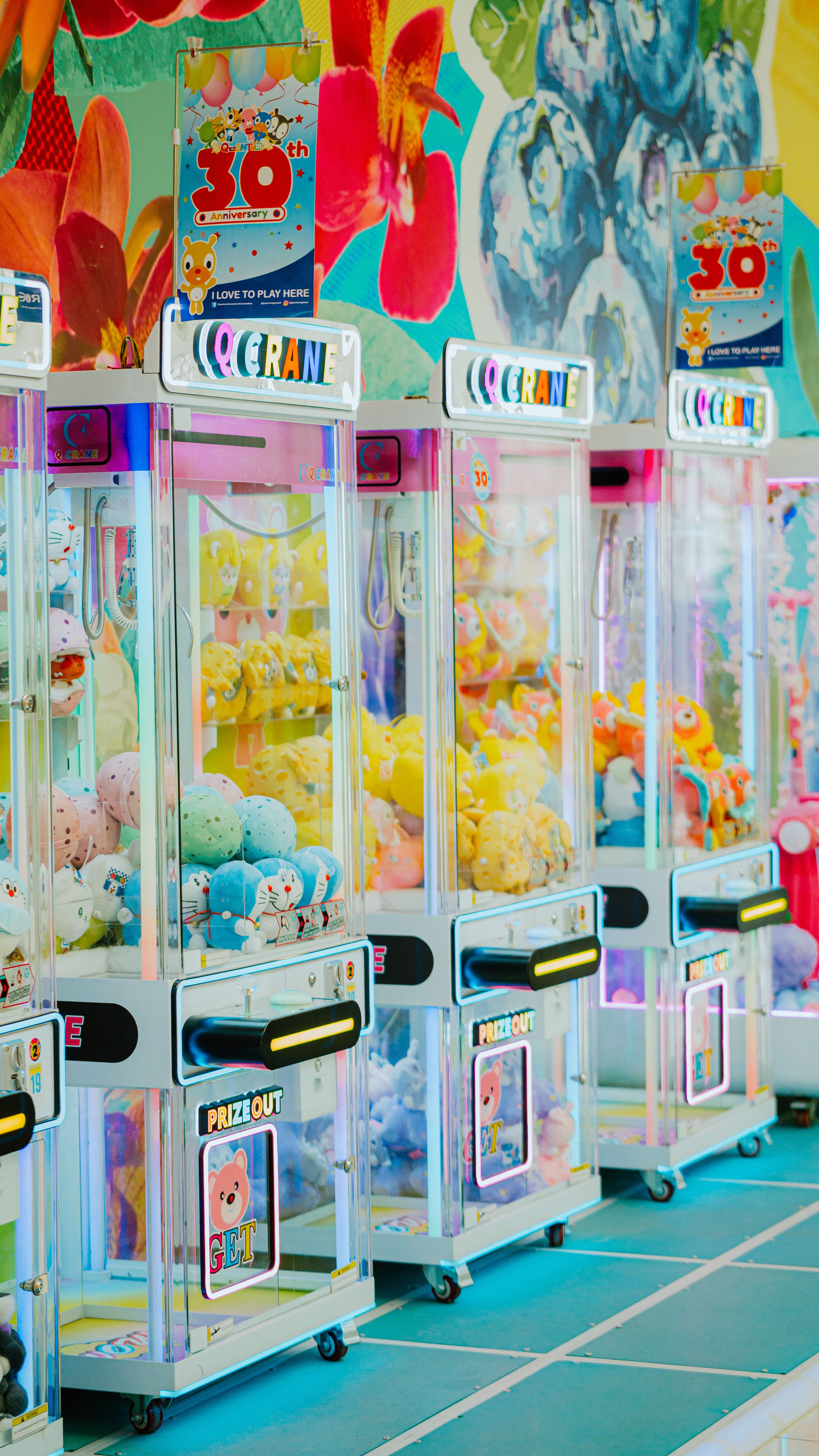 Colorful Arcade Claw Machine Row in Indoor Setting · Free Stock Photo