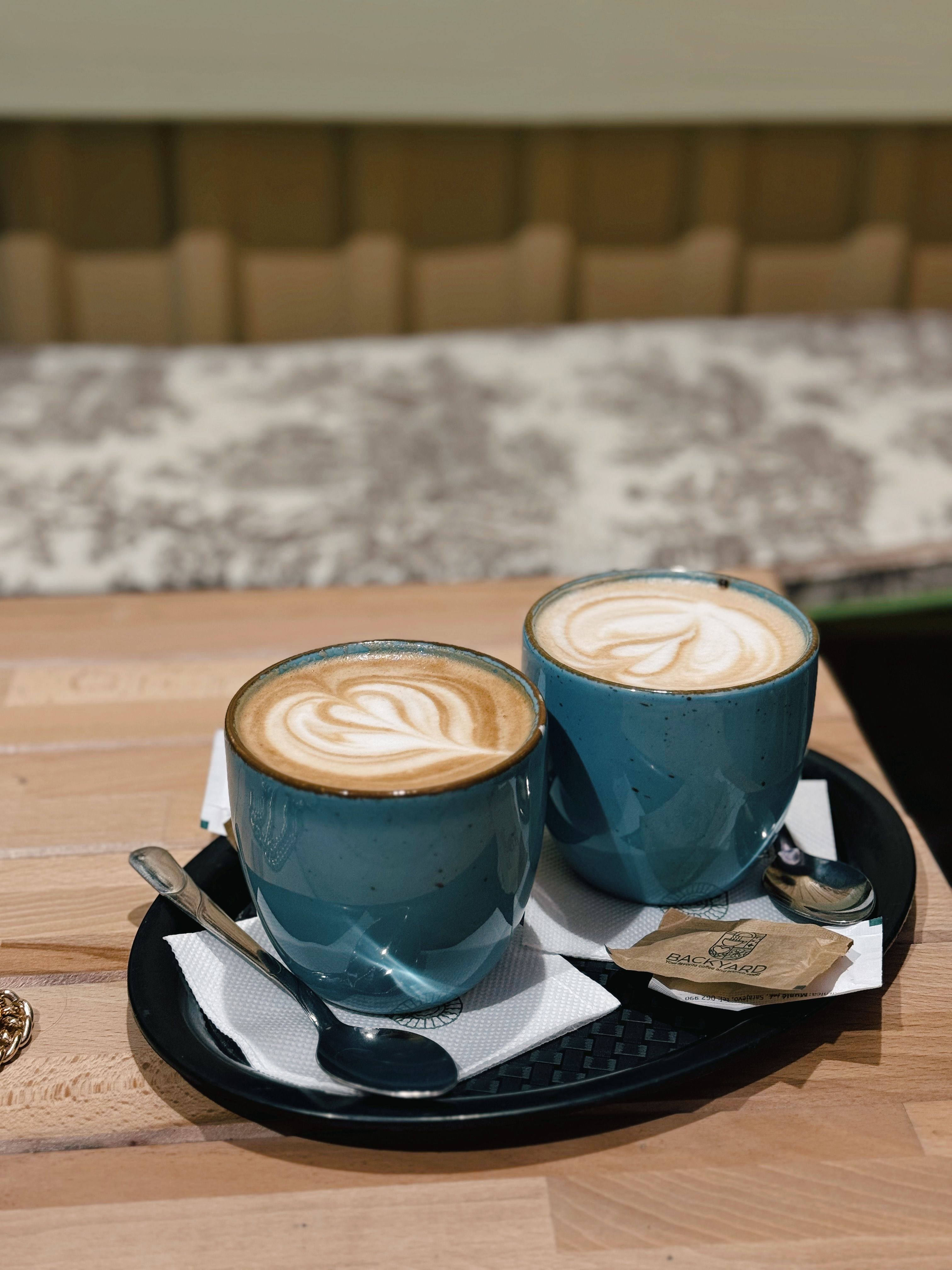 Two Lattes with Latte Art in Blue Cups · Free Stock Photo