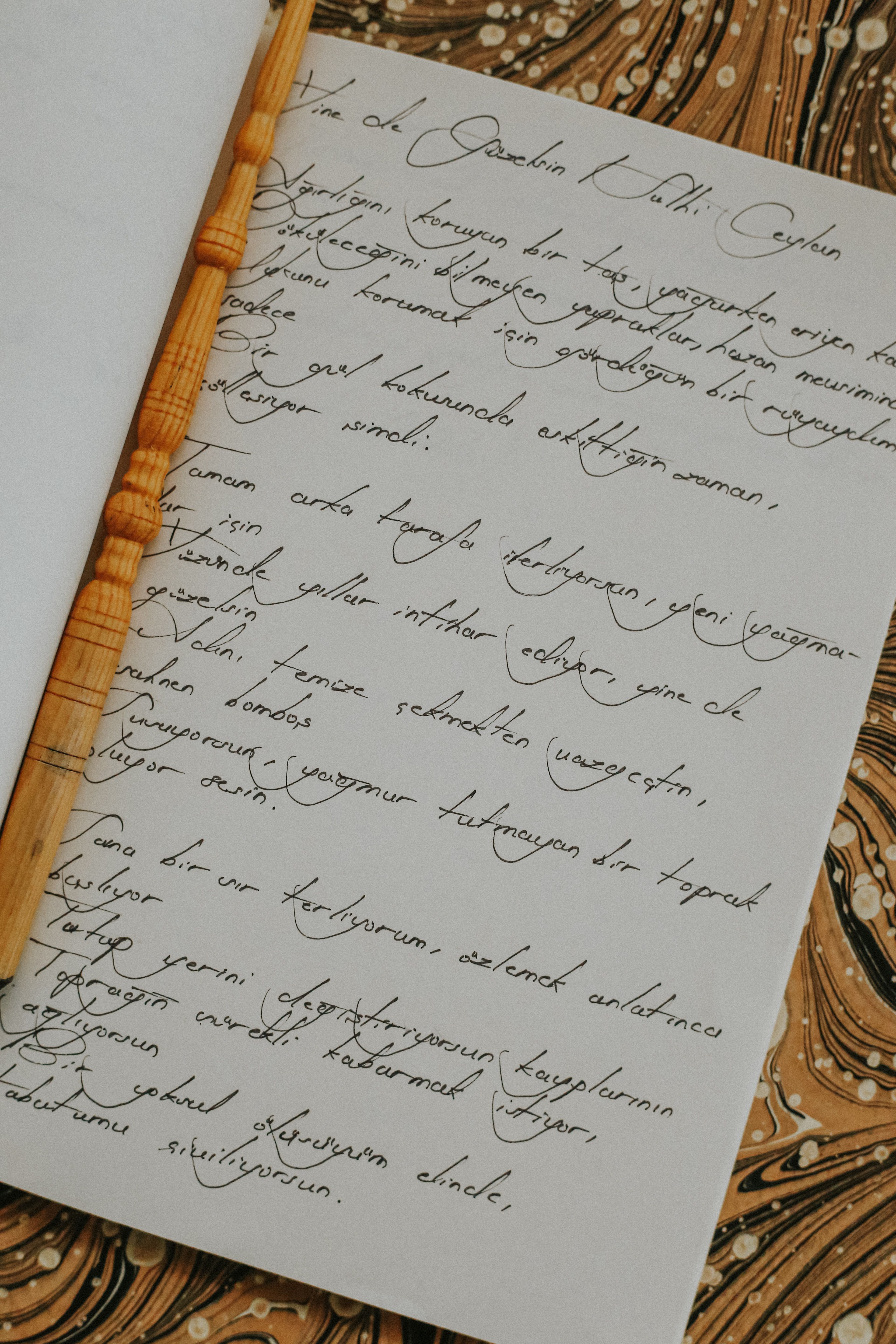 Elegant Handwritten Calligraphy on Notebook Page · Free Stock Photo