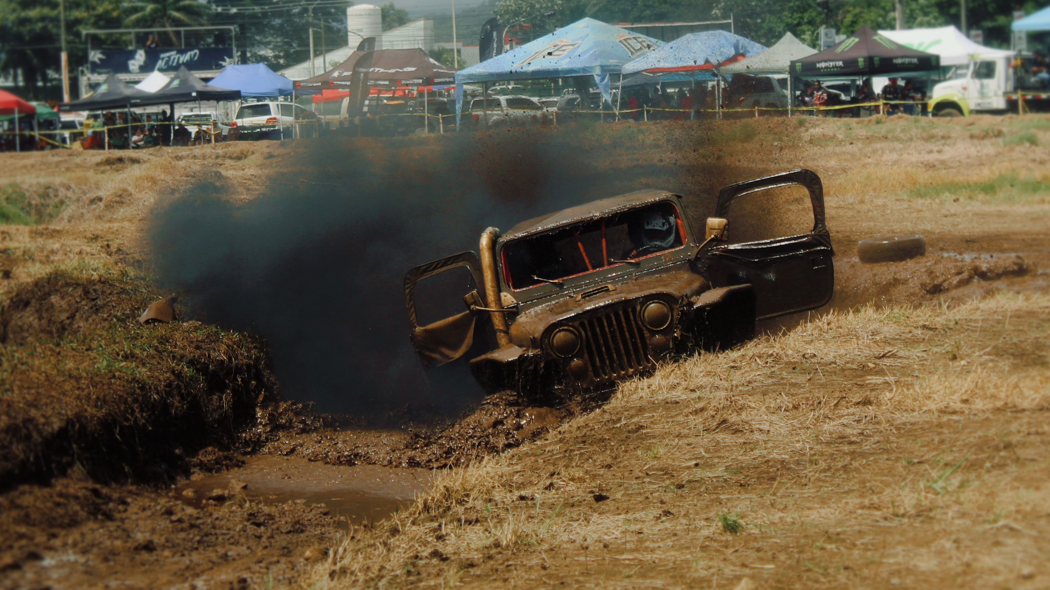 Intense Off-Road Vehicle Mud Racing Action · Free Stock Photo