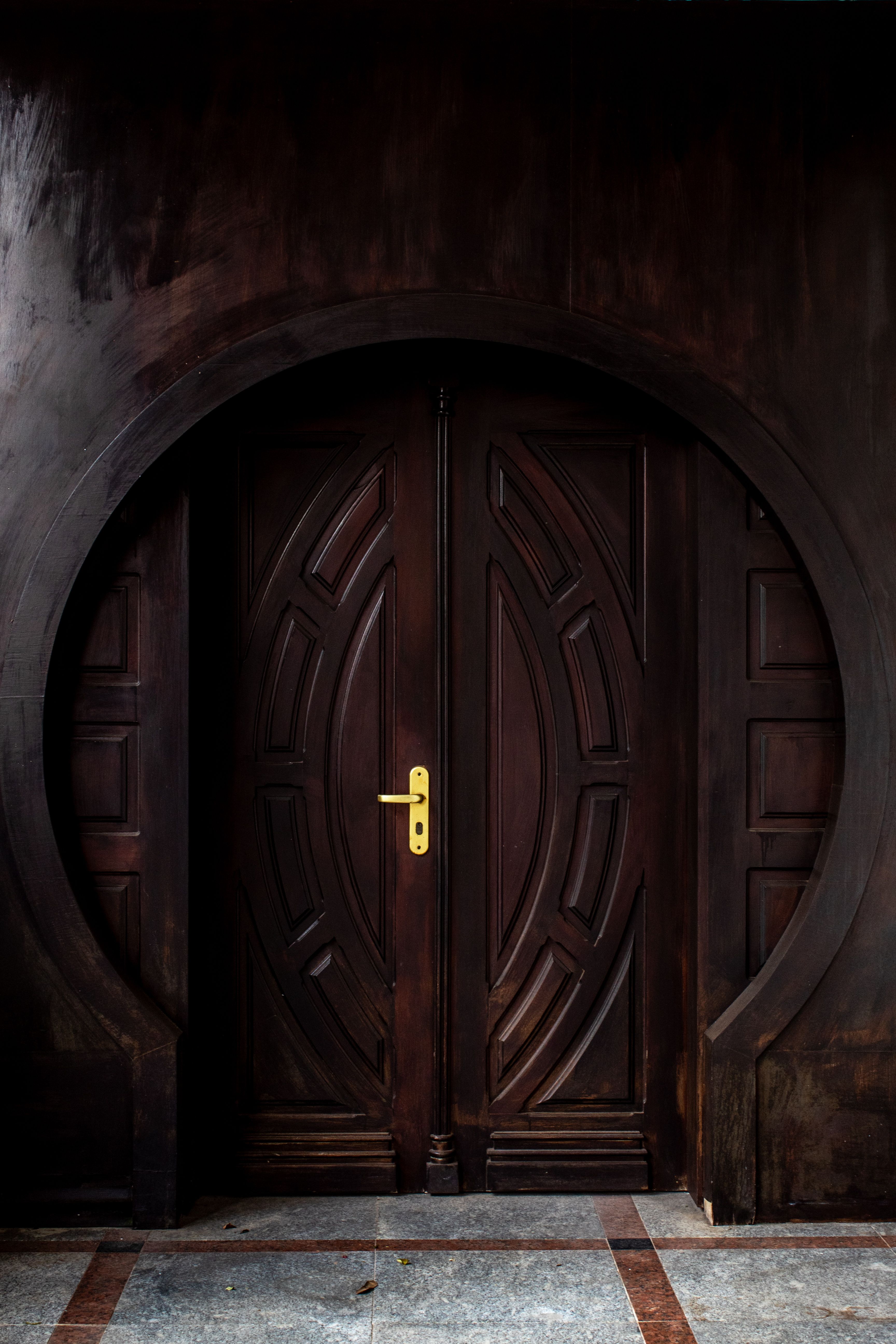 Elegant Dark Wooden Door with Circular Design · Free Stock Photo