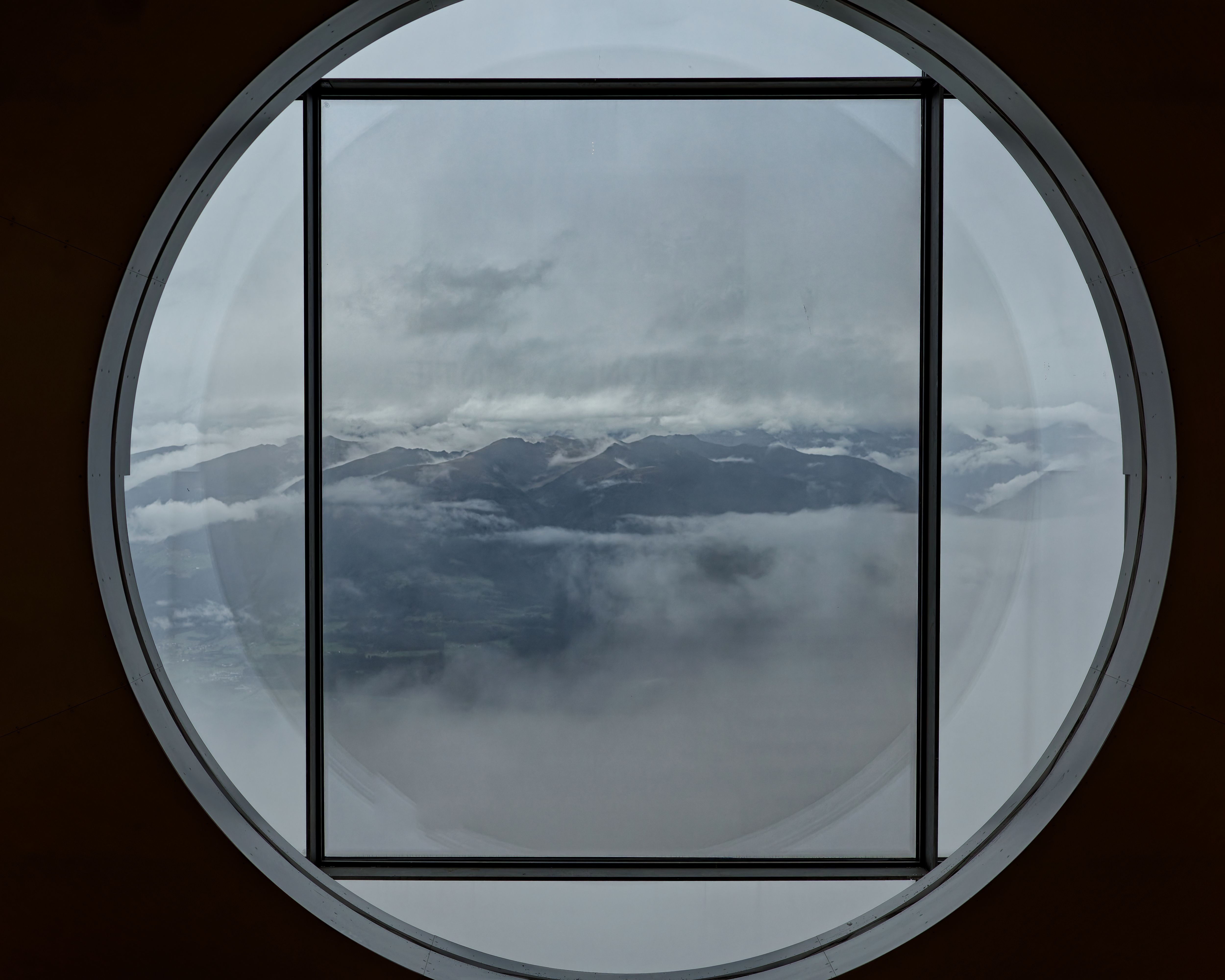 Circular Window View of Misty Mountains · Free Stock Photo