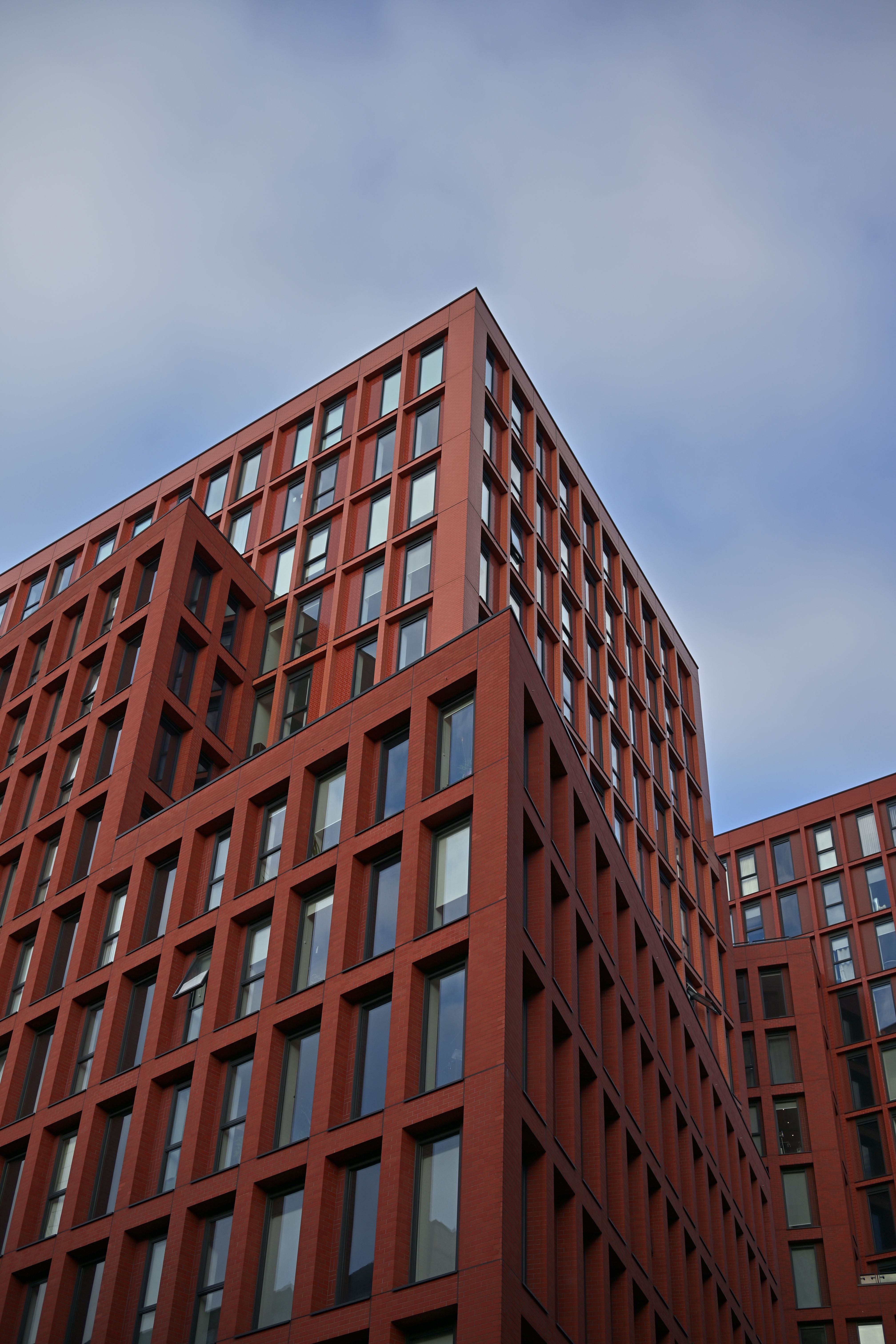 Modern Red Brick Building Against Blue Sky · Free Stock Photo