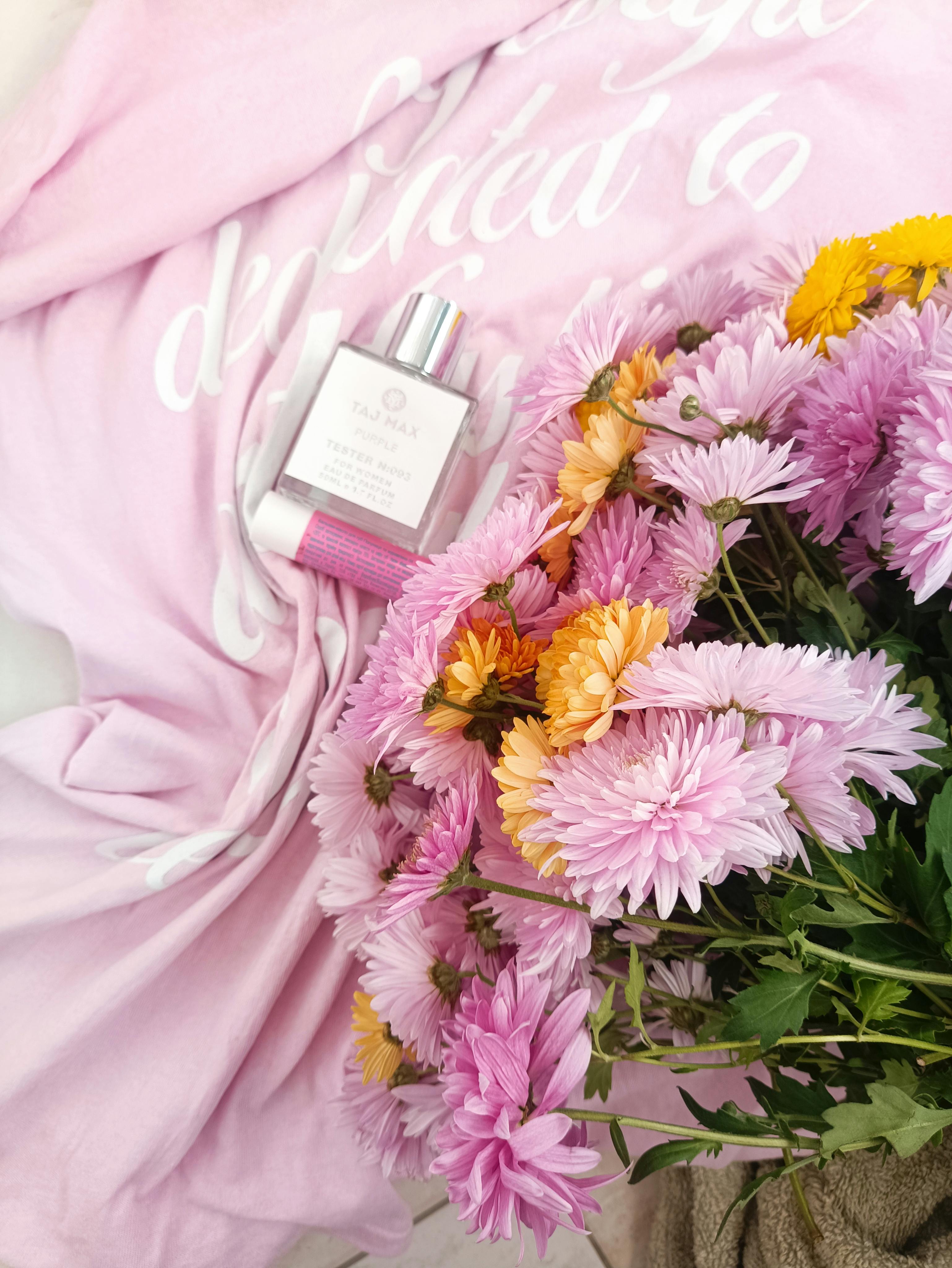 Pink Floral Arrangement with Perfume and Textured Background · Free ...