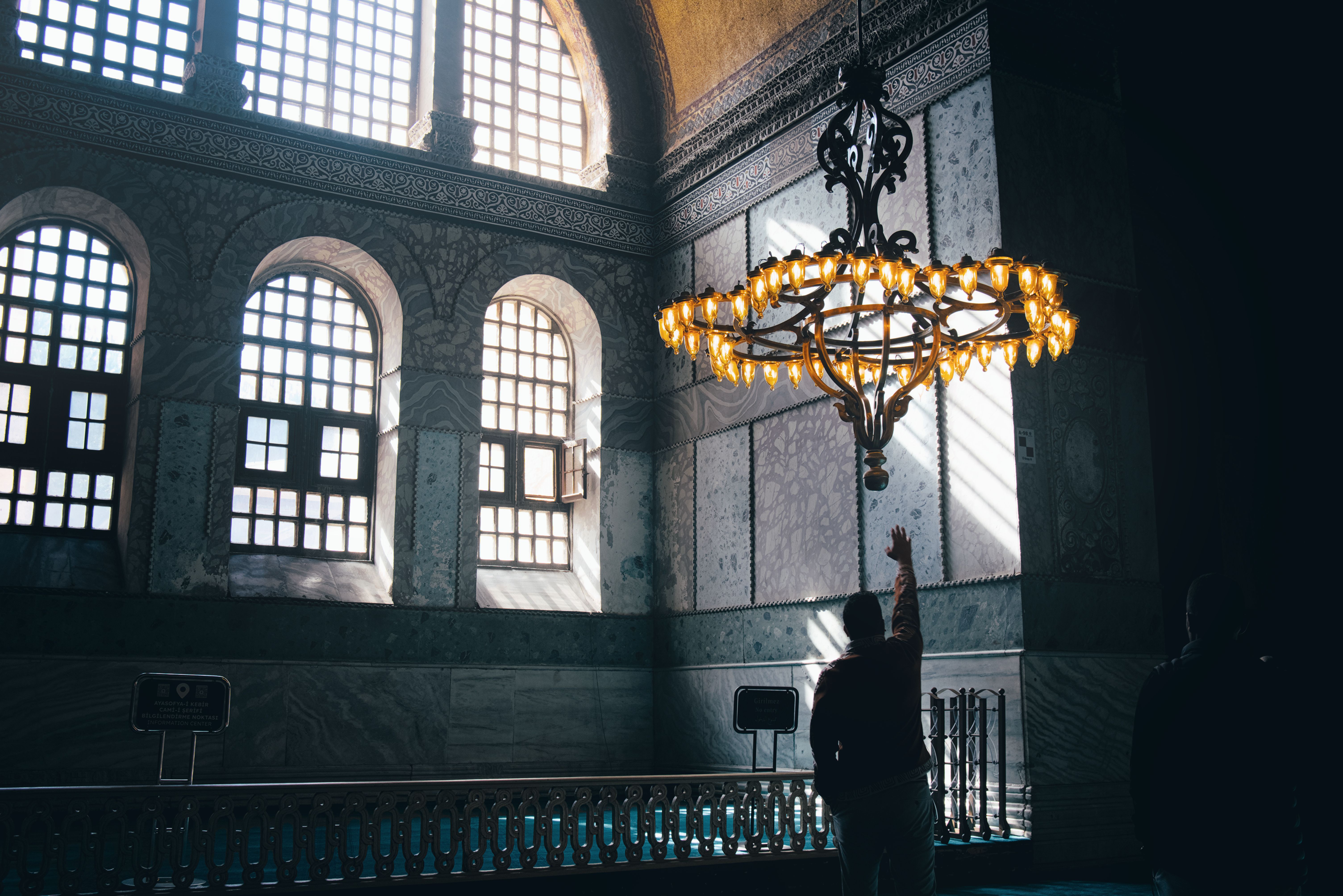 Person in Historical Interiors with Chandelier · Free Stock Photo