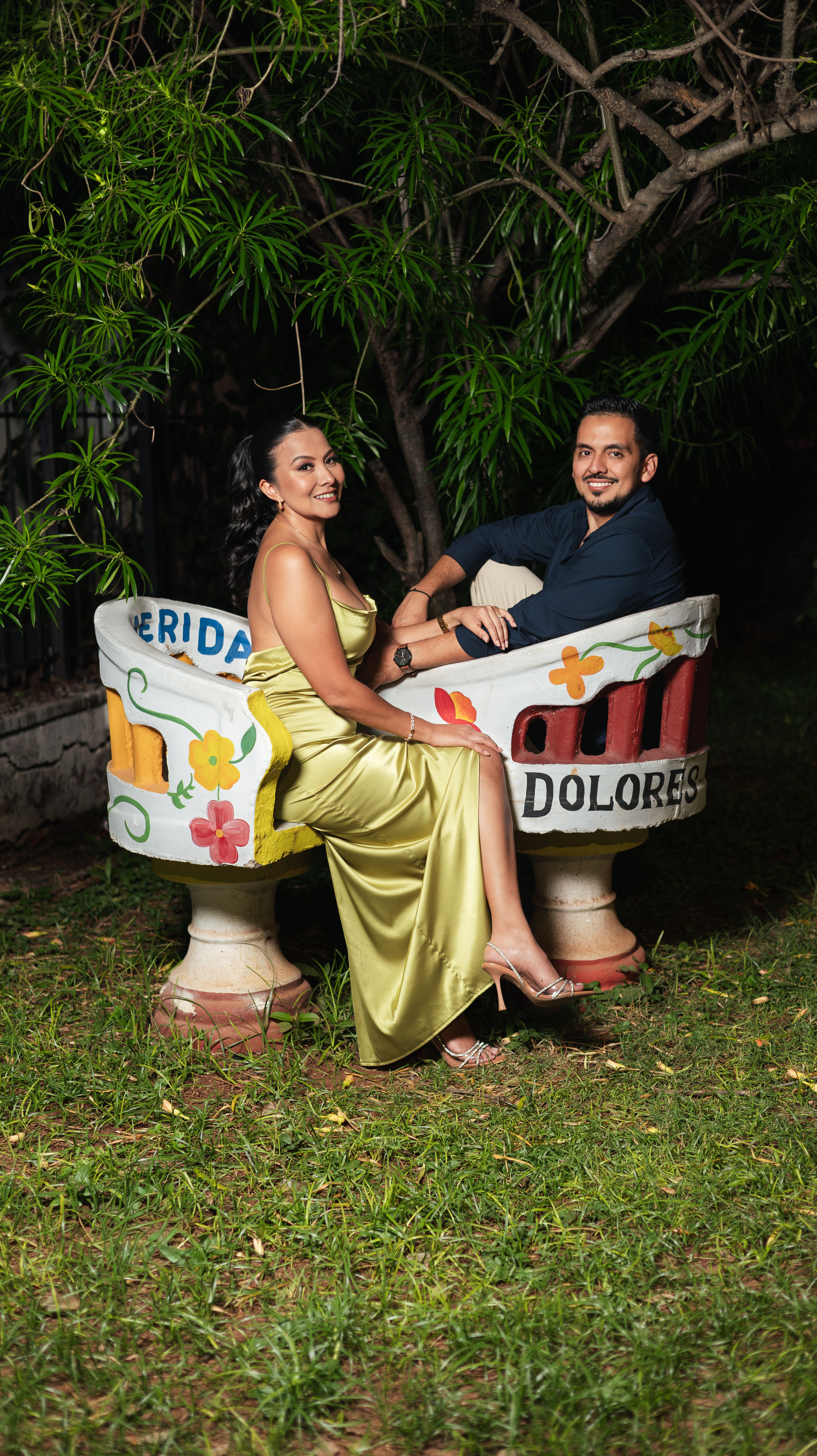 Elegant Couple Posing on Decorative Bench Outdoors · Free Stock Photo