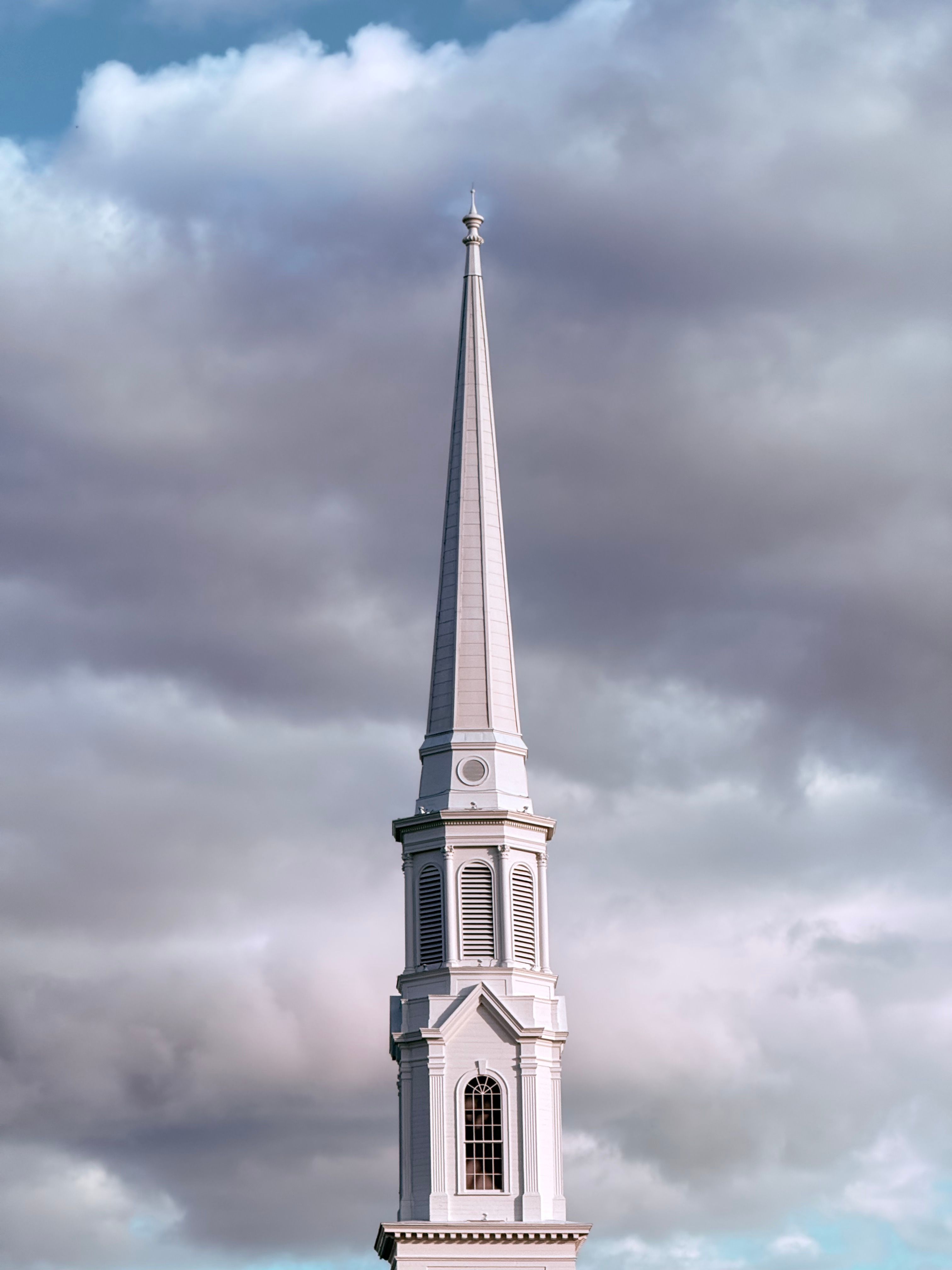 Tall White Church Steeple Against Cloudy Sky · Free Stock Photo