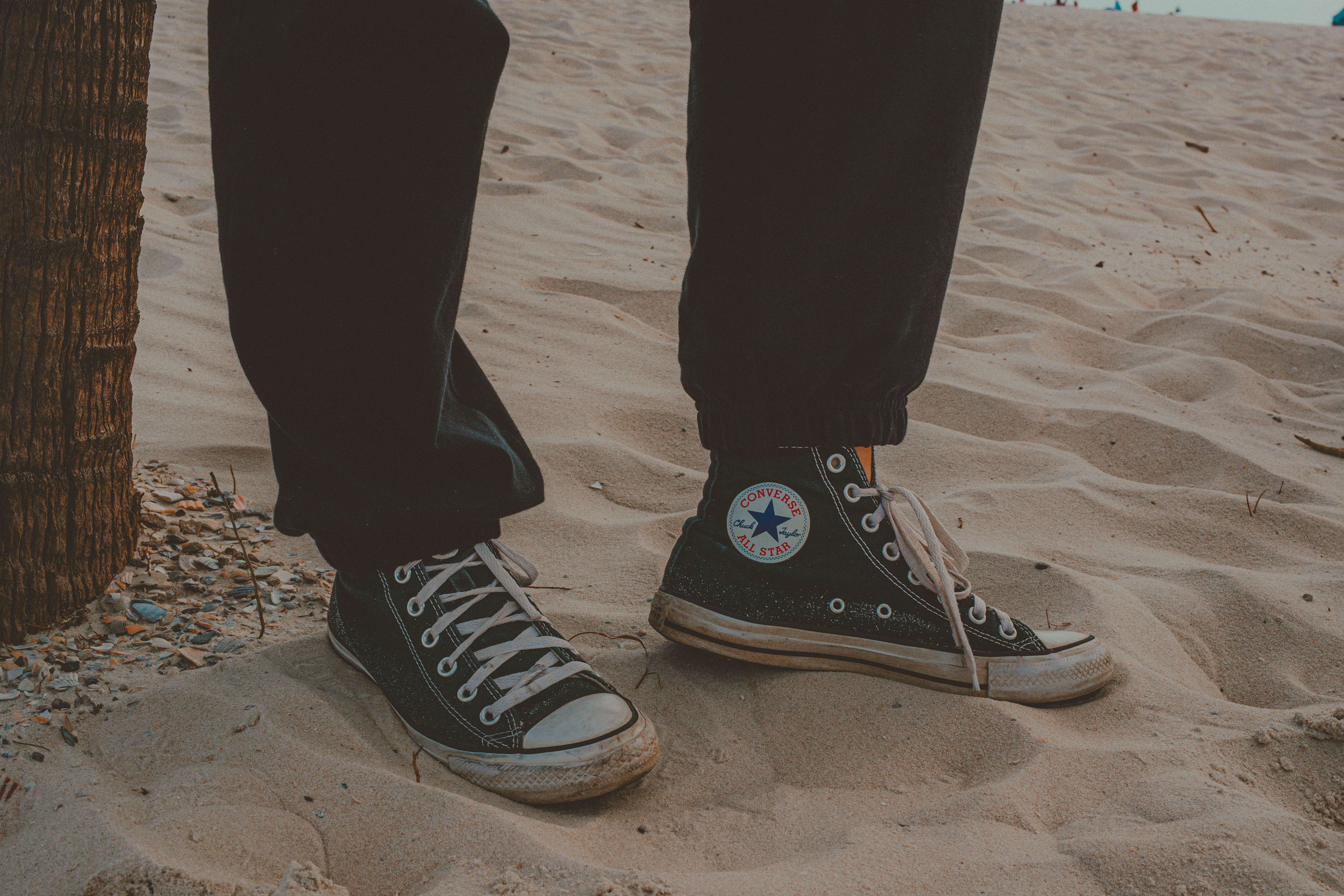 Black Converse Sneakers on Sandy Beach in Alabama · Free Stock Photo