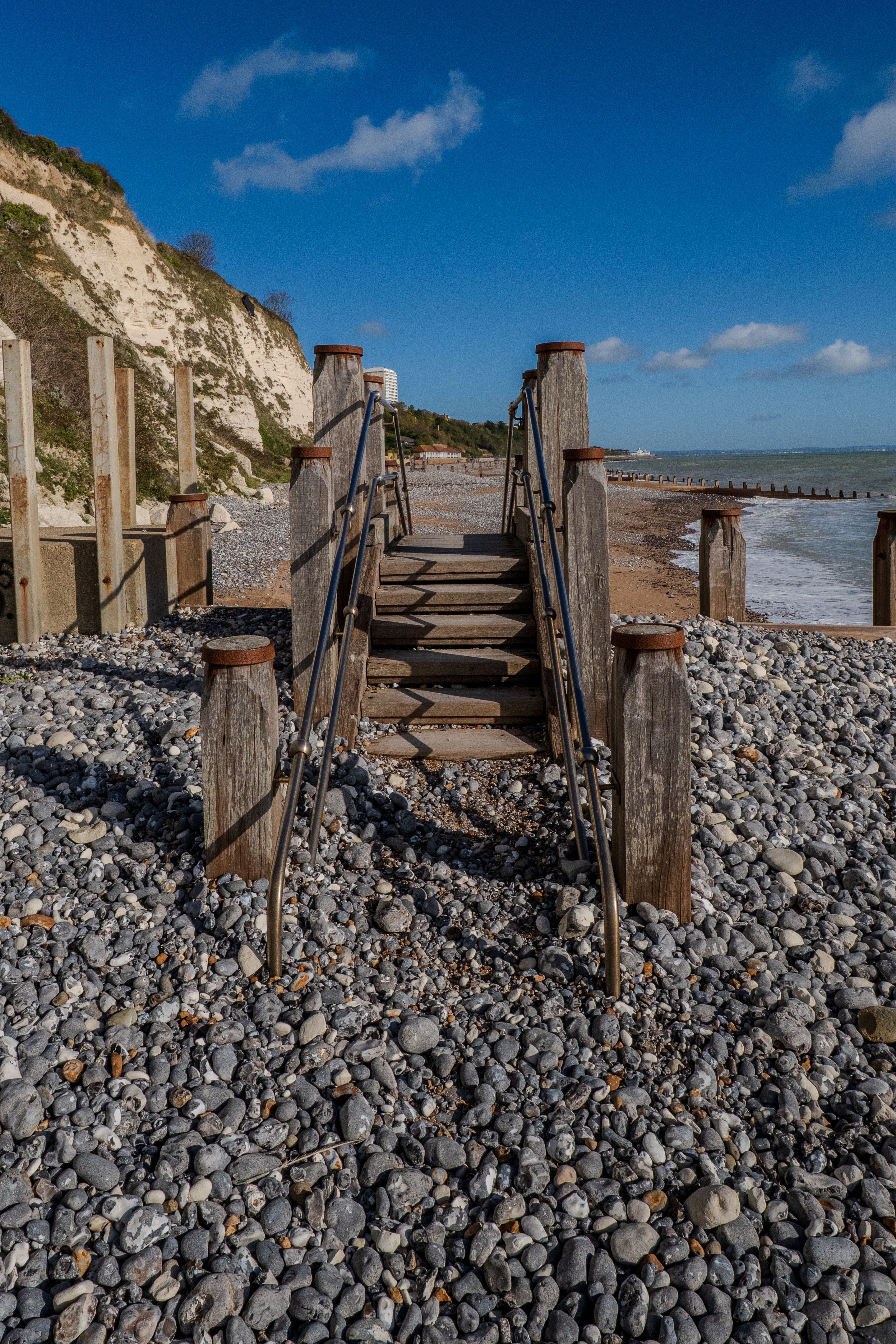 Rustic Beach Staircase on Pebbled Shore · Free Stock Photo