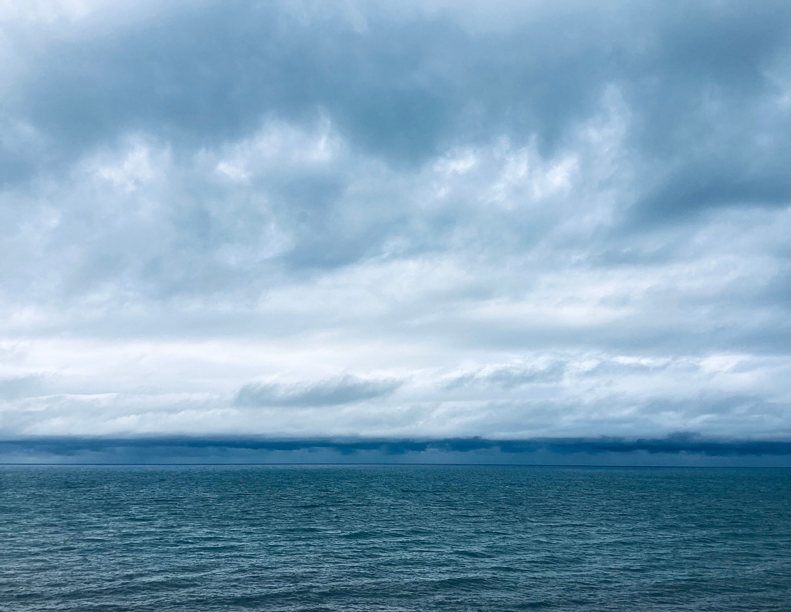 Tranquil Ocean Under Cloudy Sky · Free Stock Photo