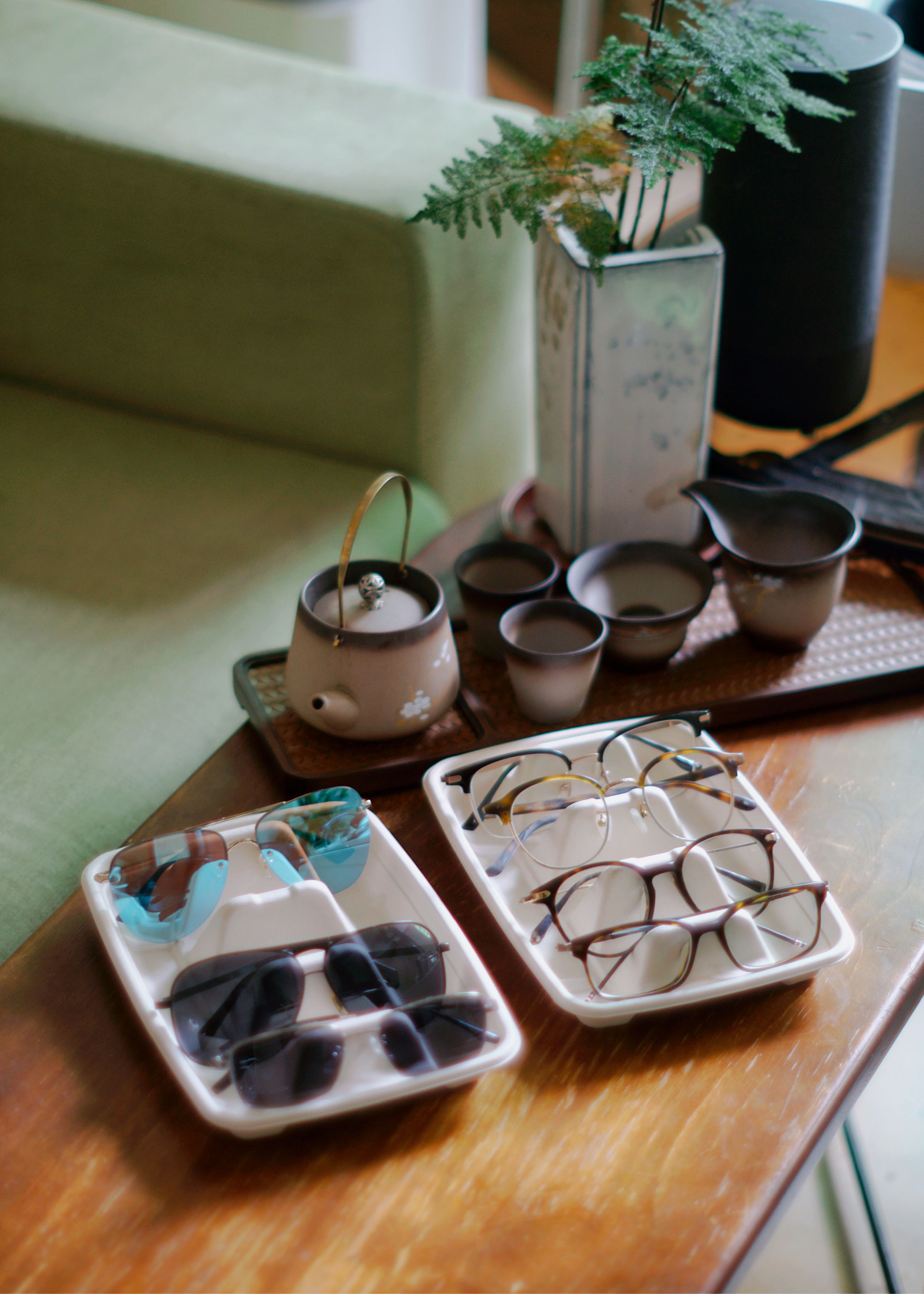 Tea Set and Eyewear on Wooden Table · Free Stock Photo