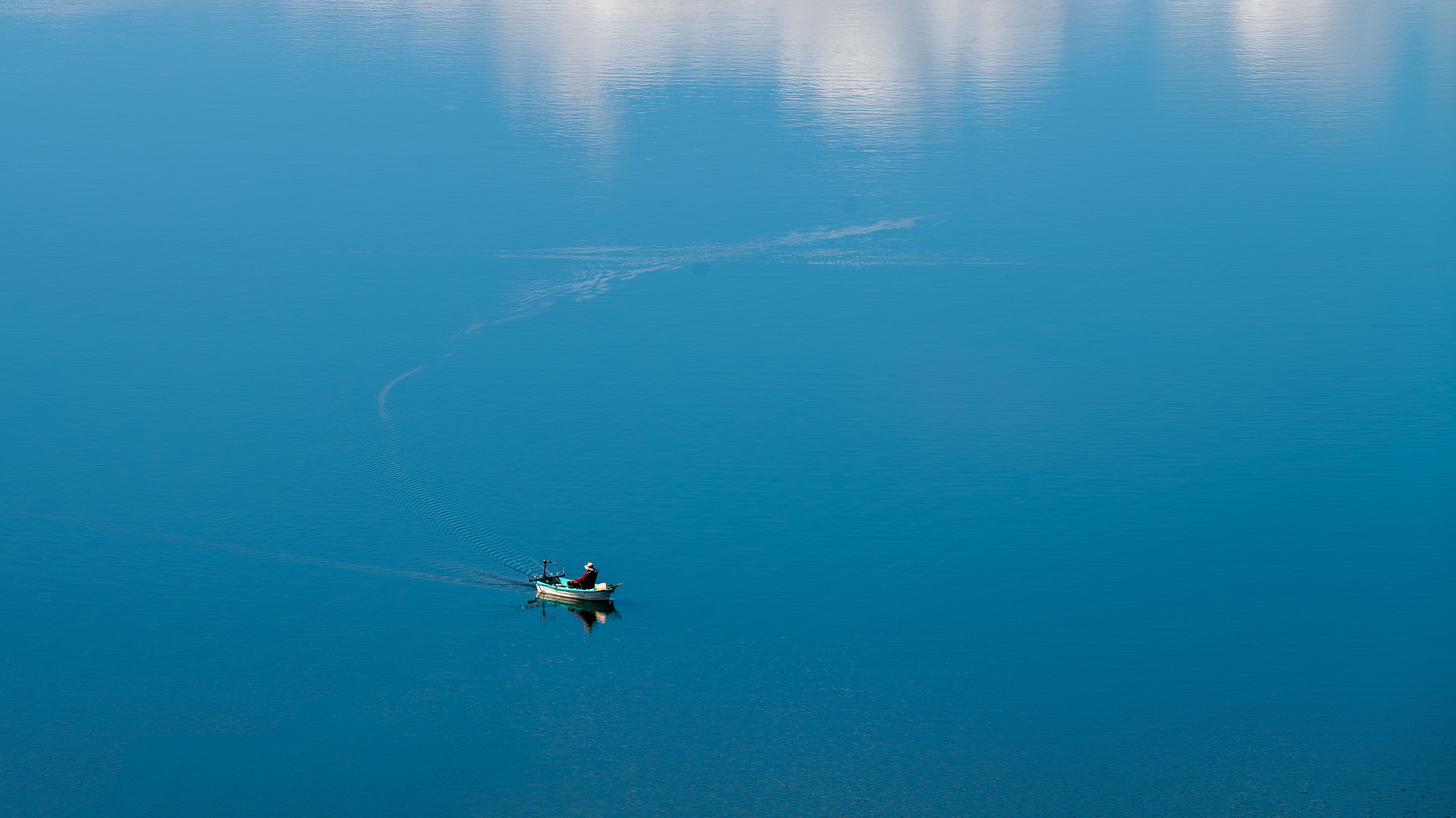 Serene Fishing on Tranquil Blue Lake Waters · Free Stock Photo