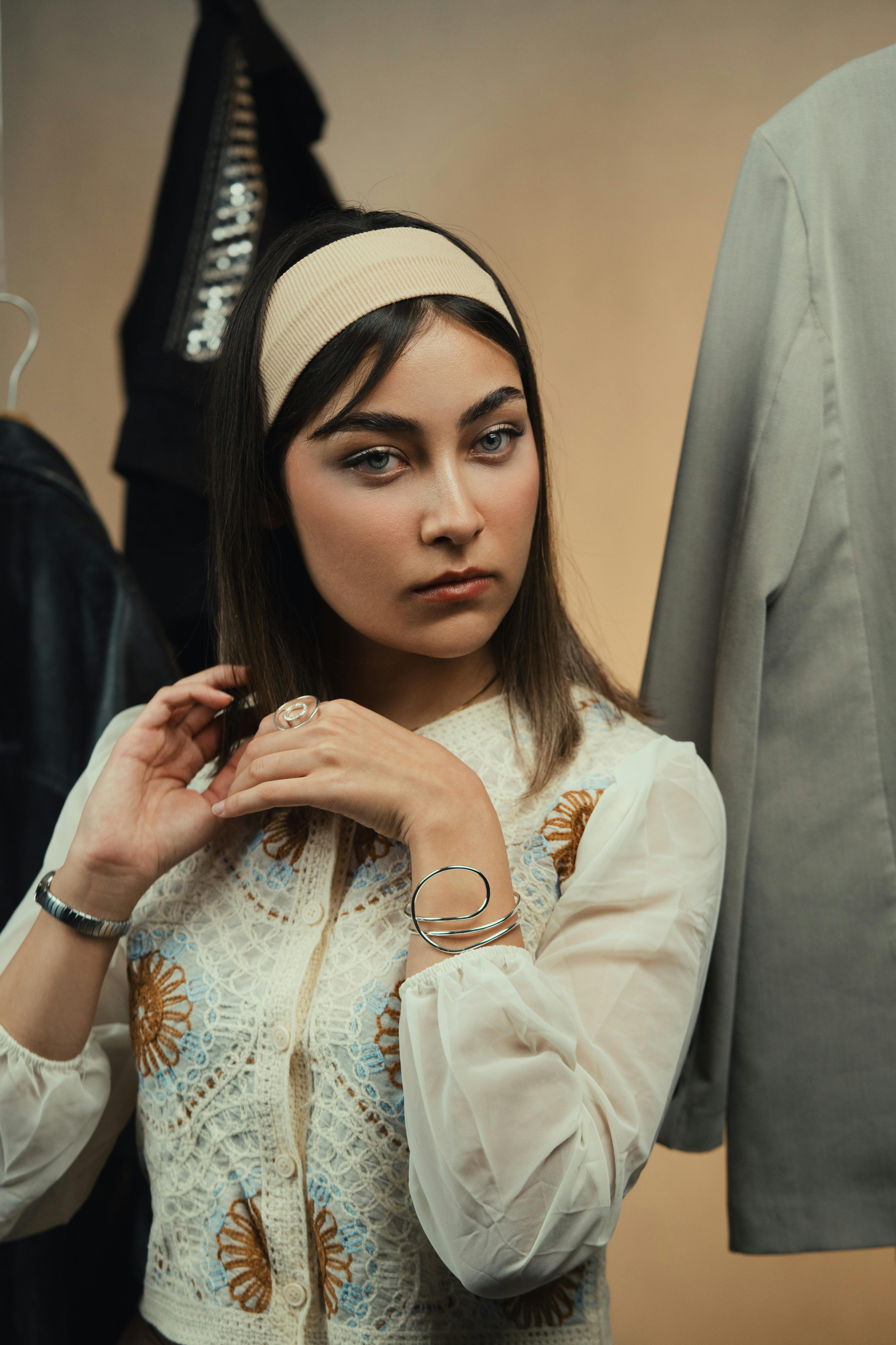 Vintage Style Portrait of Woman Amidst Clothing · Free Stock Photo