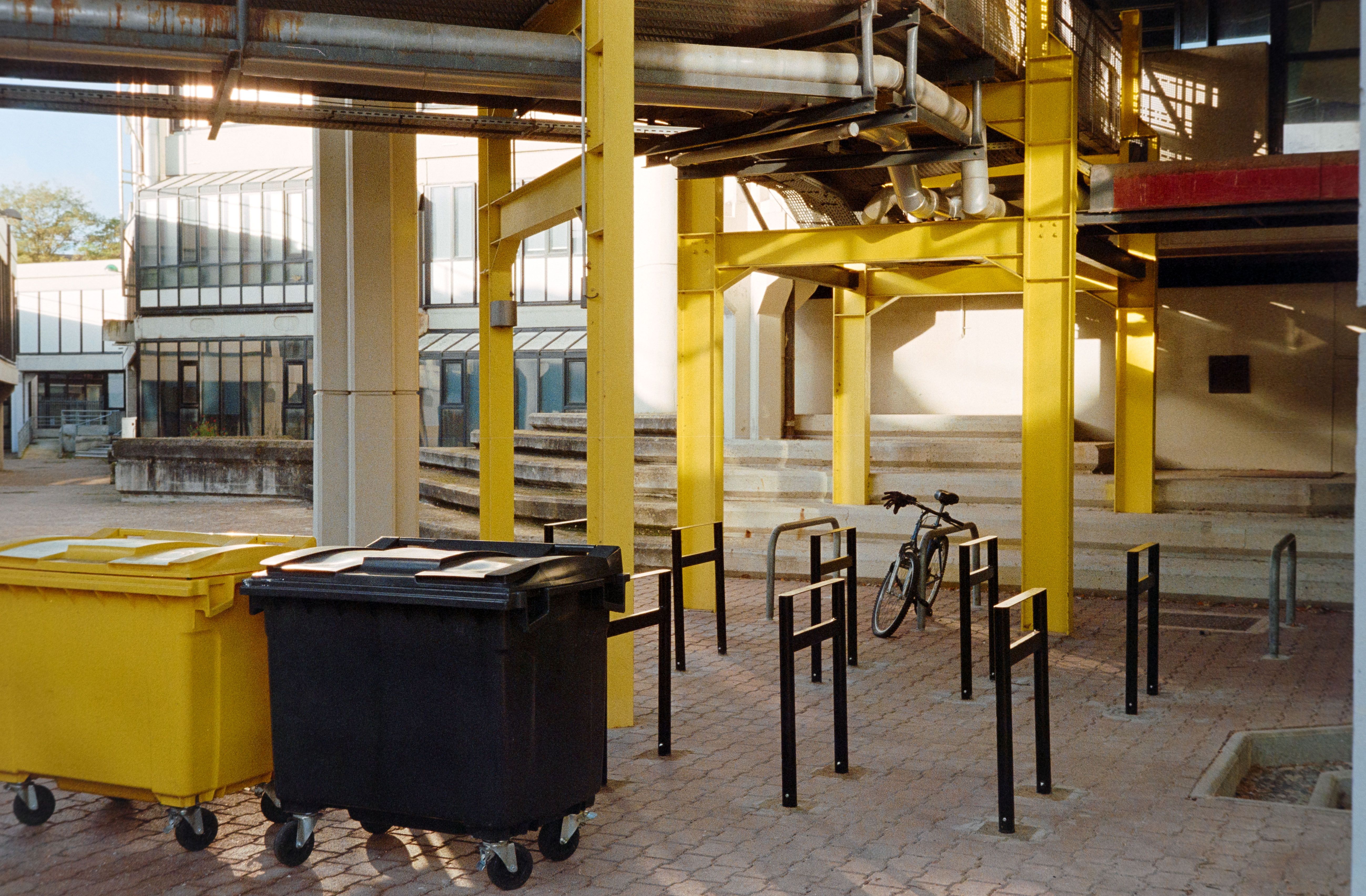 Urban Industrial Scene with Bins and Bike · Free Stock Photo