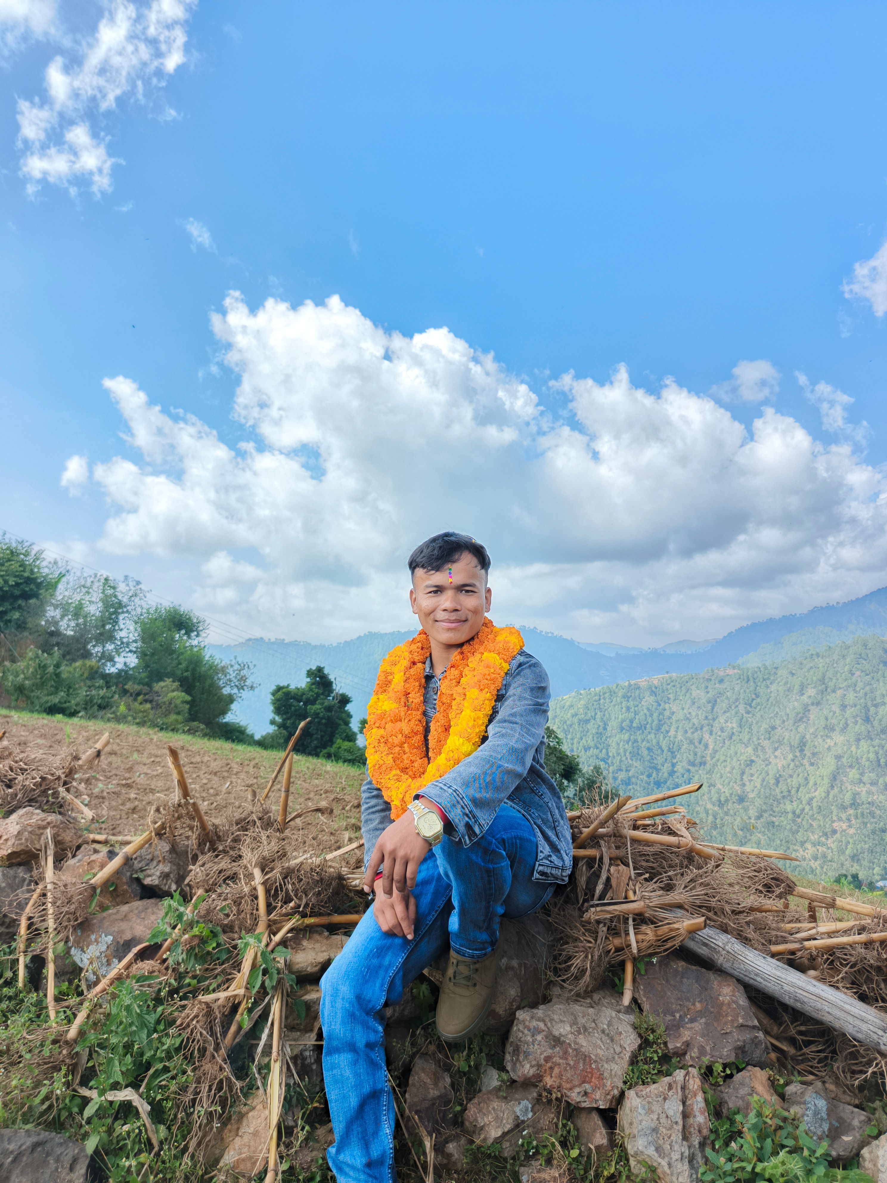 Smiling Man with Marigold Garland Outdoors · Free Stock Photo
