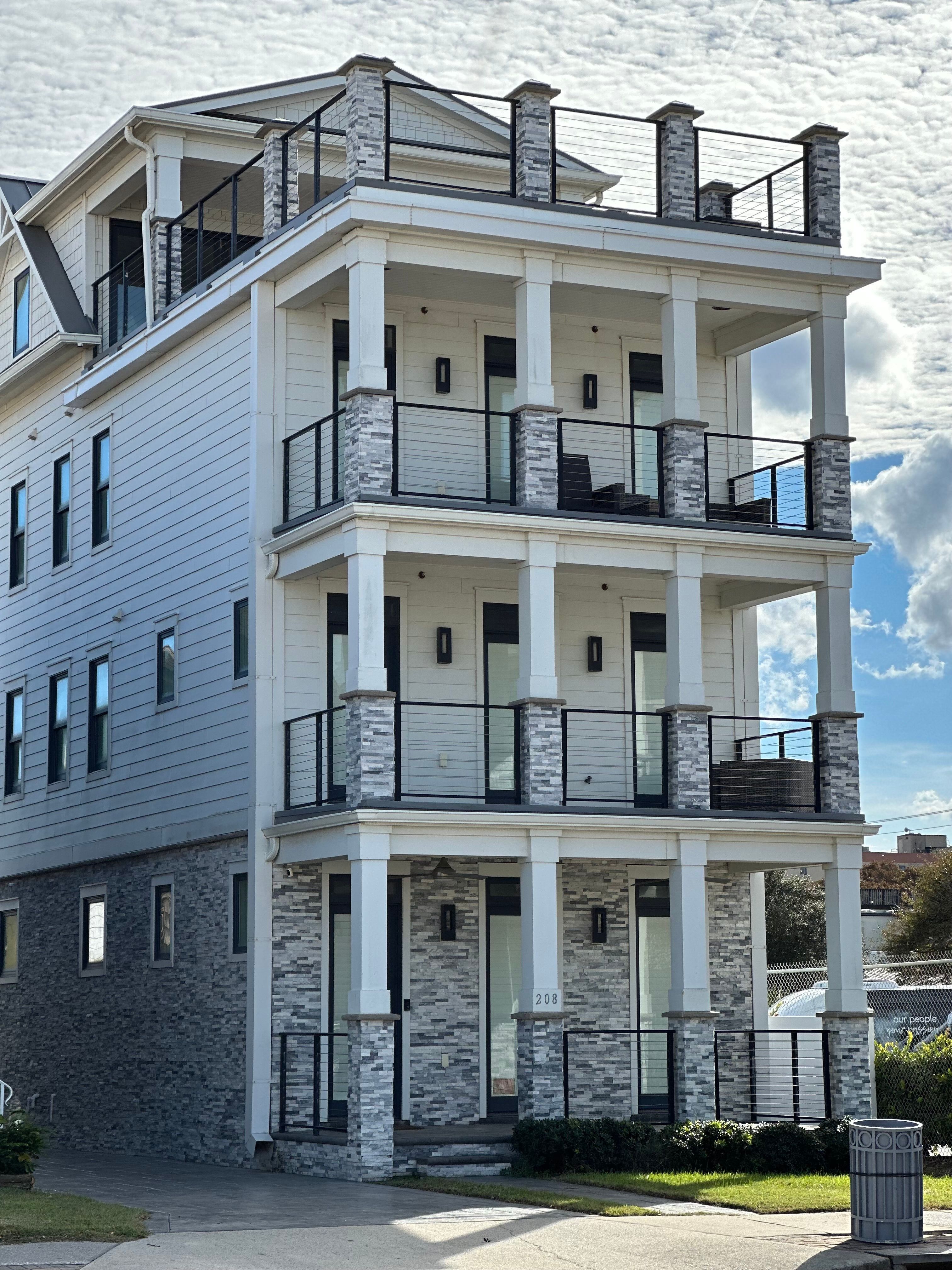 Modern Multi-Story Stone and Glass Building · Free Stock Photo