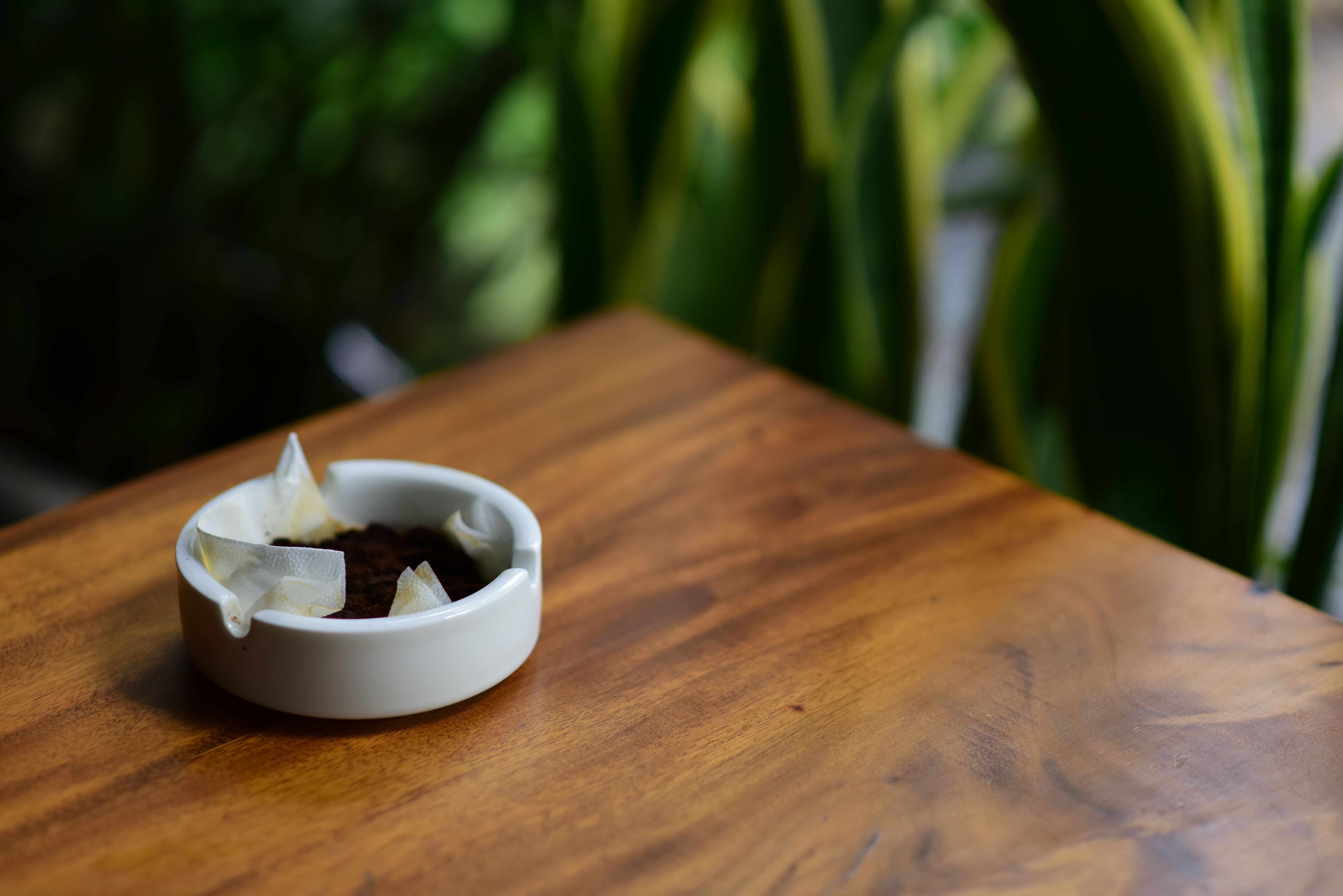 Coffee Grounds in Ashtray on Wooden Table · Free Stock Photo