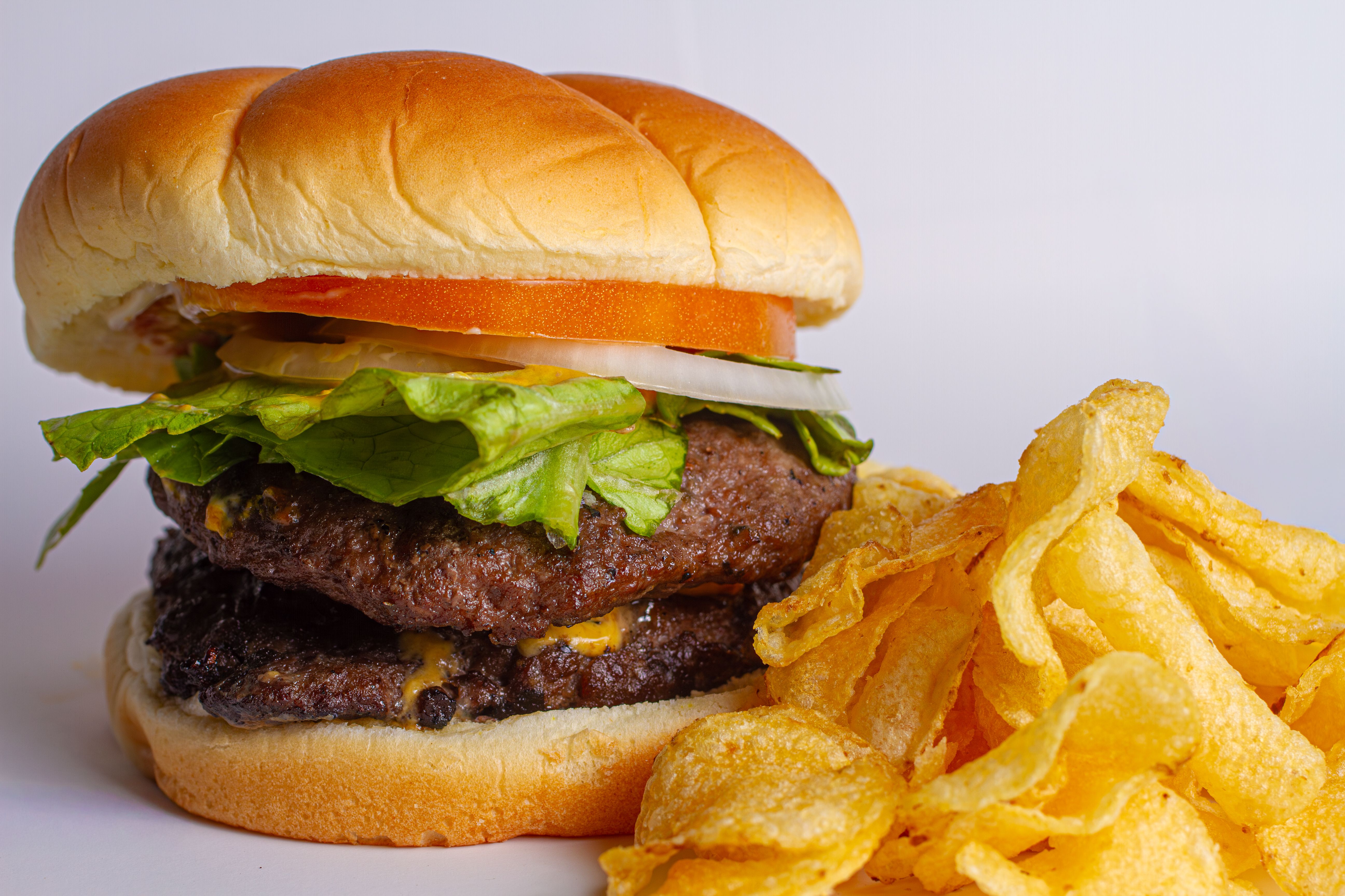 Double Cheeseburger with Crispy Potato Chips · Free Stock Photo