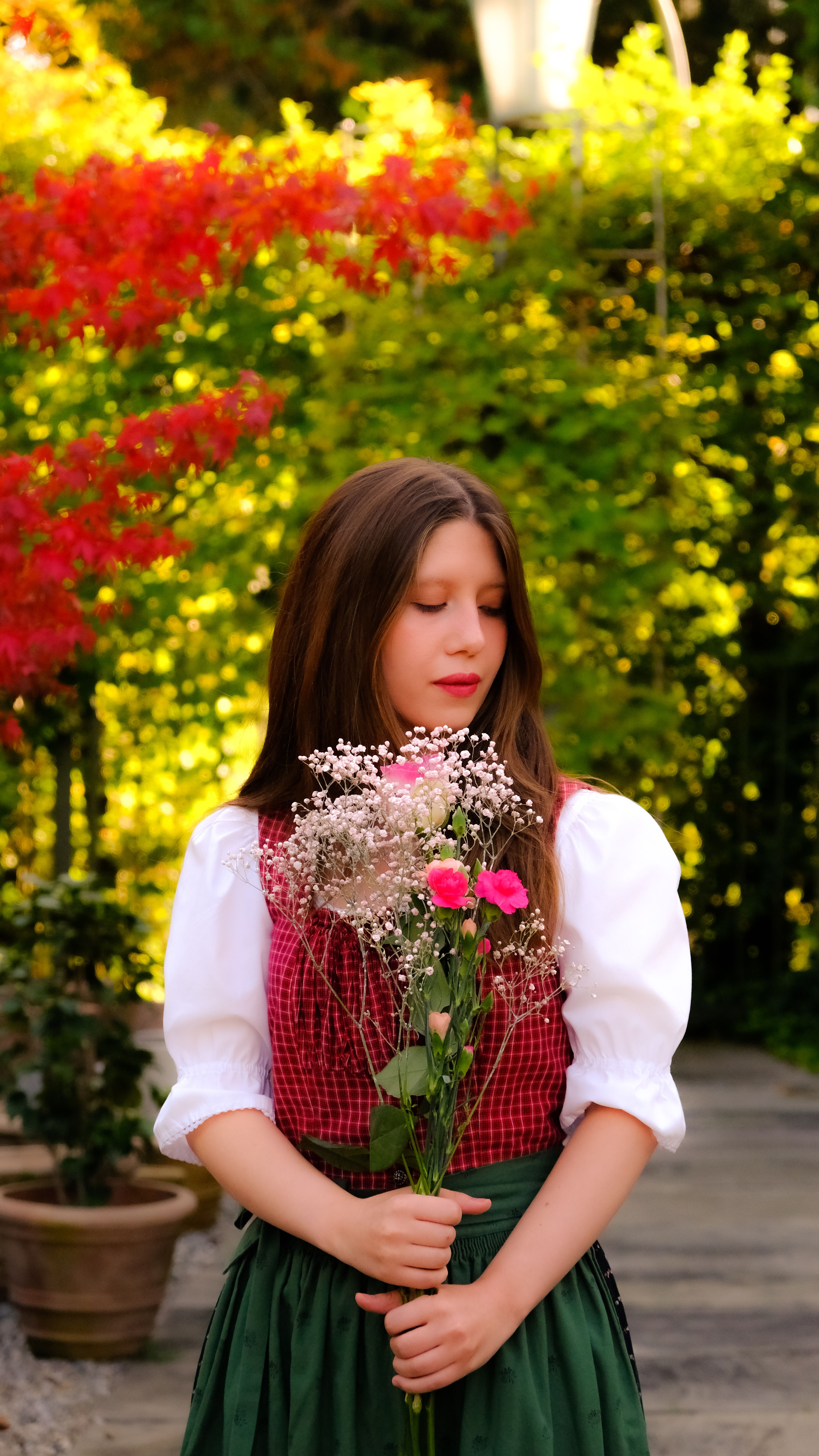 Austrian Woman in Traditional Outfit with Flowers · Free Stock Photo
