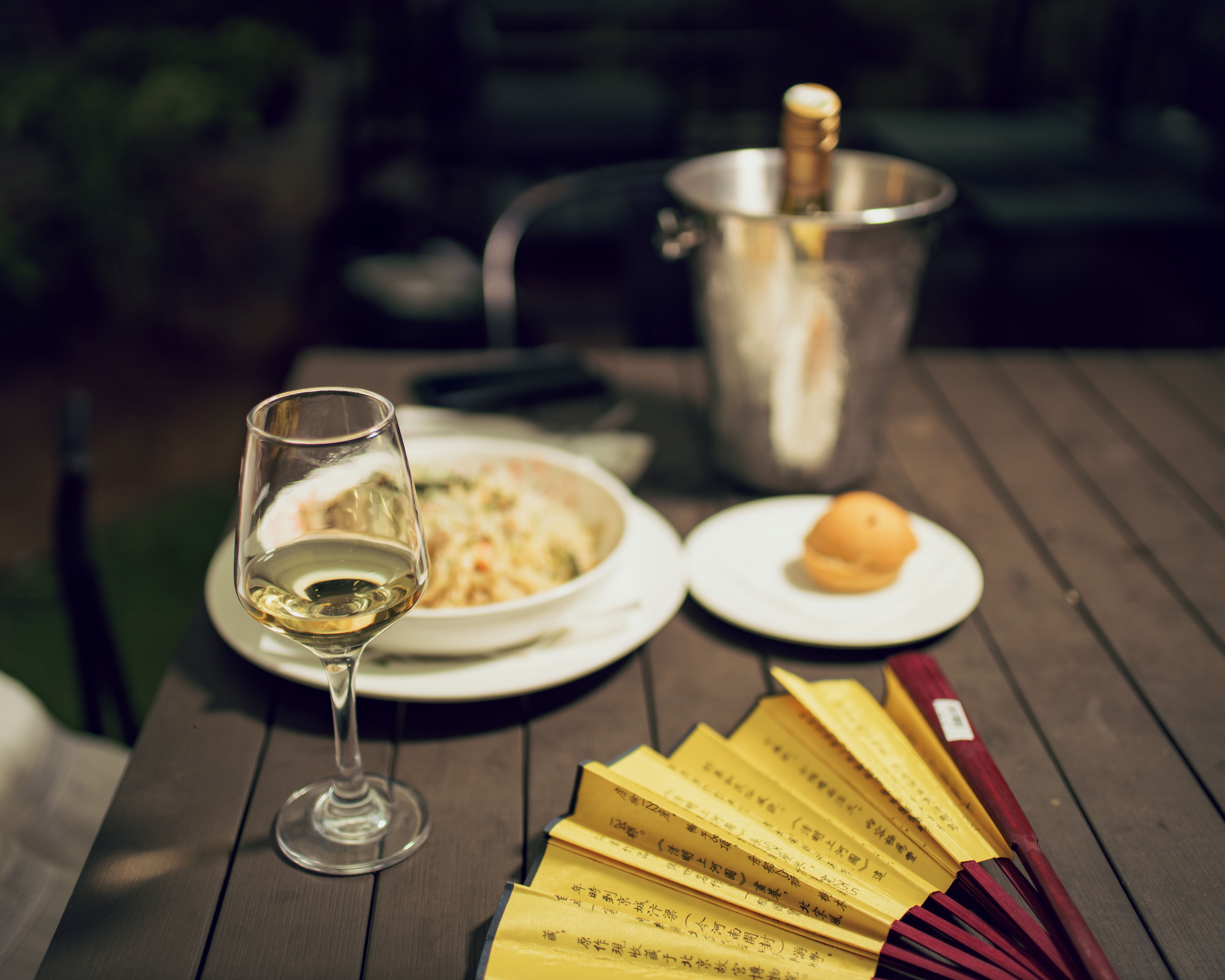 Outdoor Dining Setting with Wine and Oriental Fan · Free Stock Photo