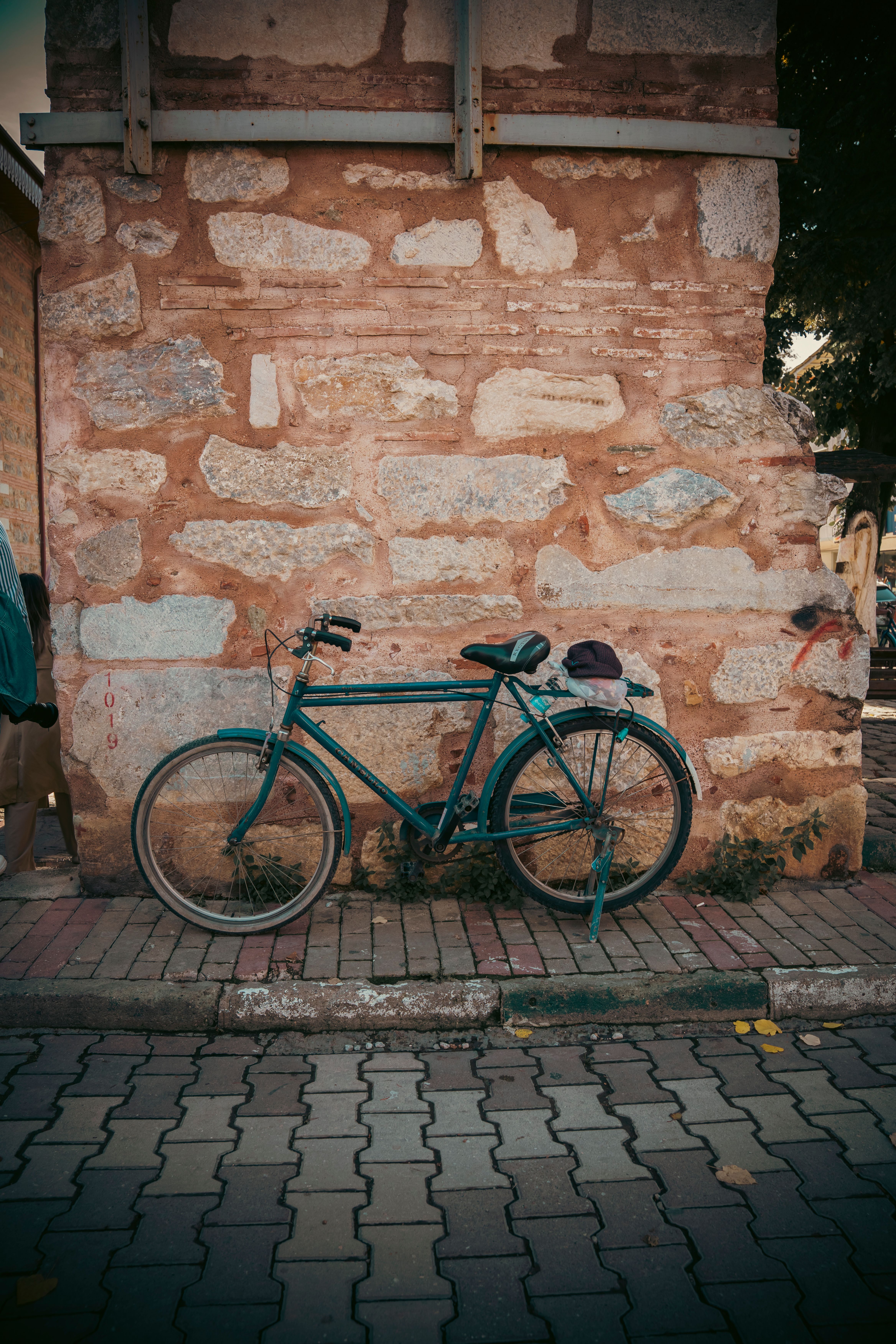 Vintage Bicycle Against Rustic Wall Outdoors · Free Stock Photo