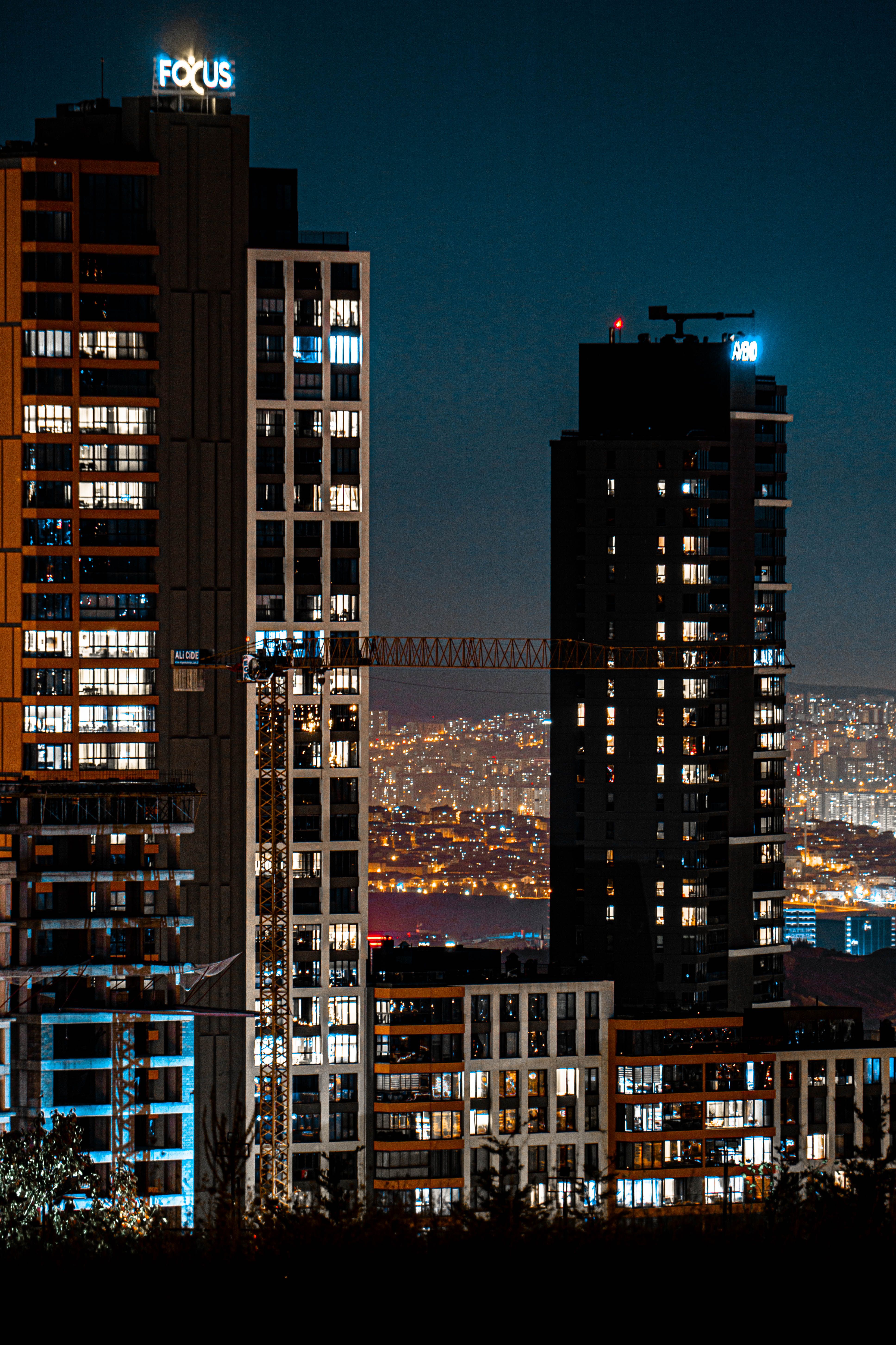 Urban Night Skyline with Illuminated Towers · Free Stock Photo