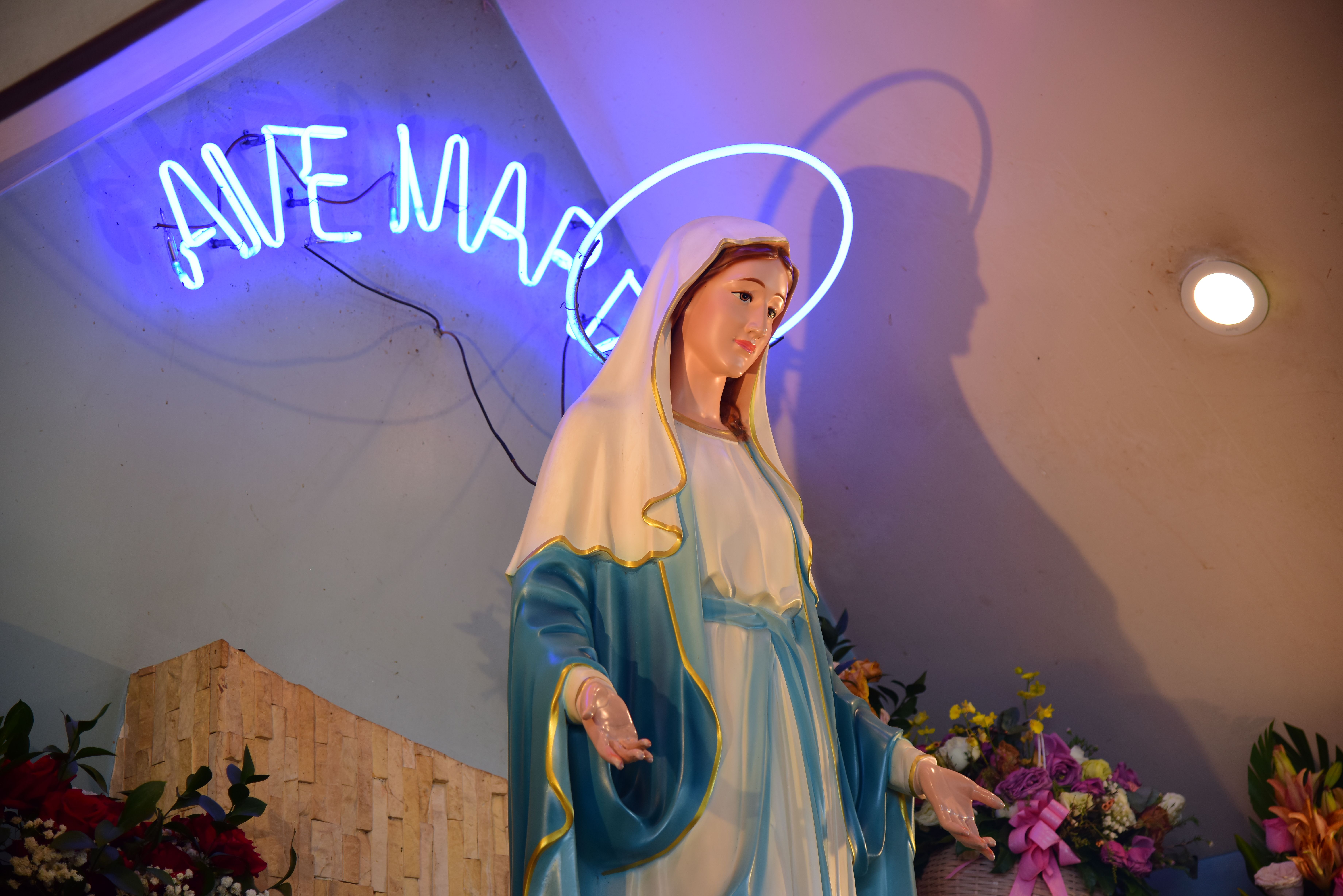 Statue of Virgin Mary with Neon Ave Maria Sign · Free Stock Photo