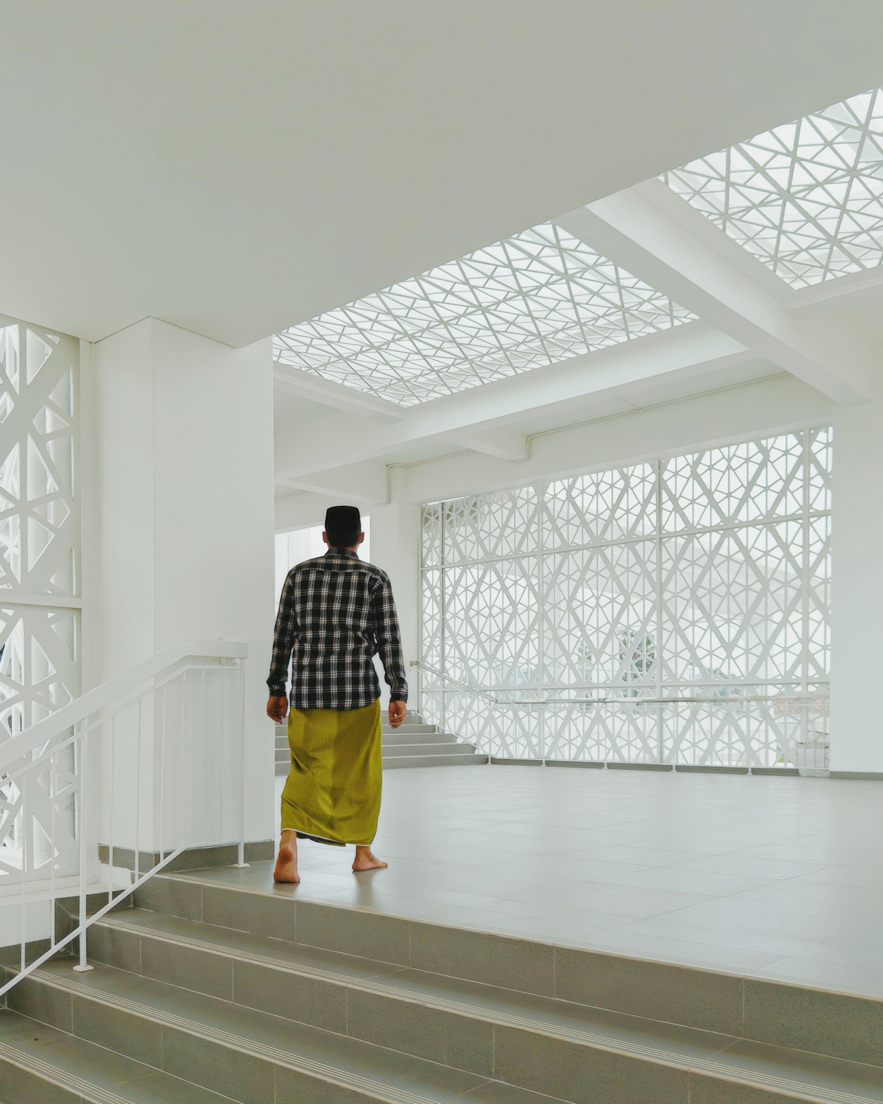Modern Mosque Interior with Traditional Attire · Free Stock Photo