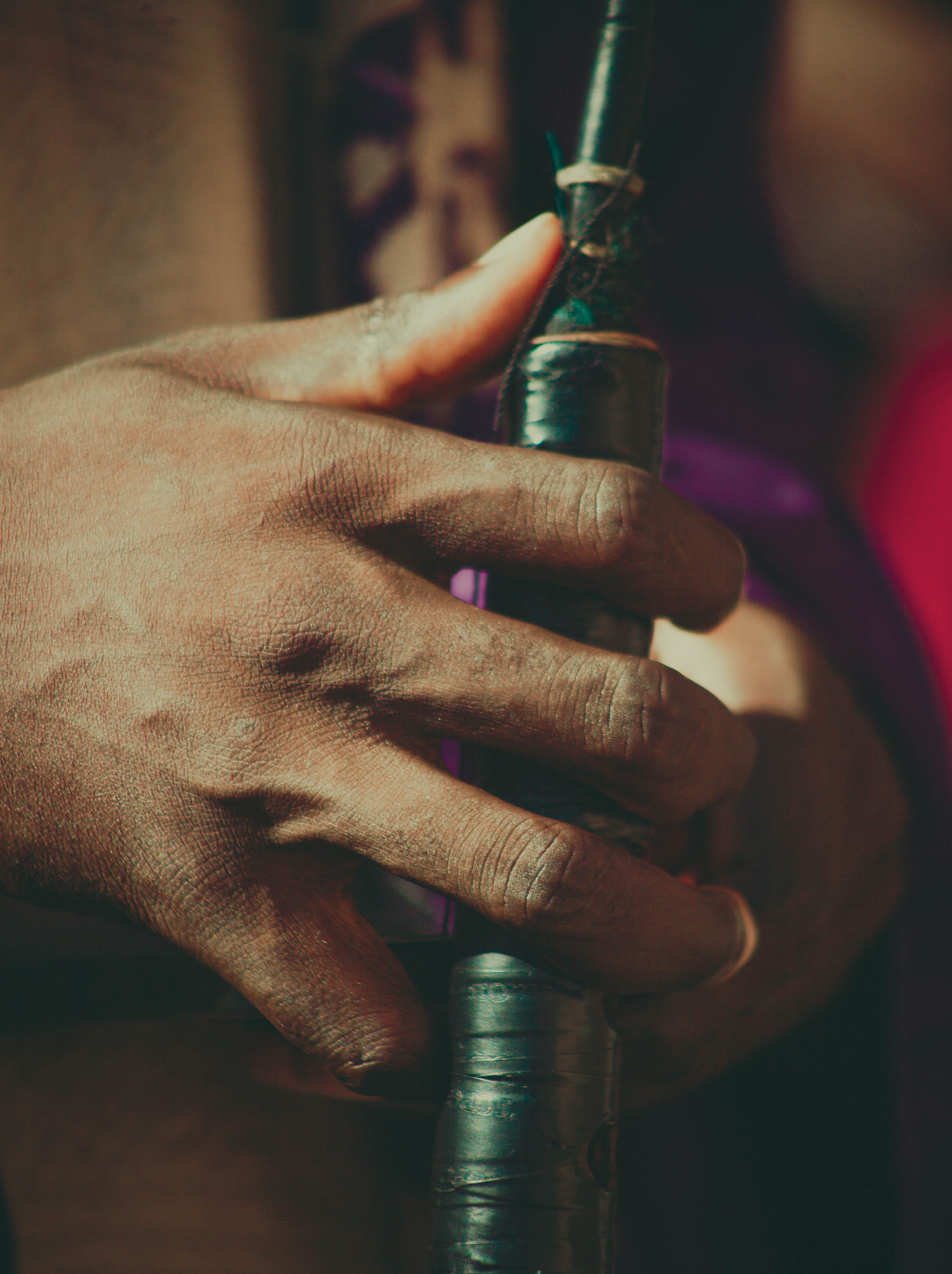 Close-Up of Hands Holding a Wind Instrument · Free Stock Photo