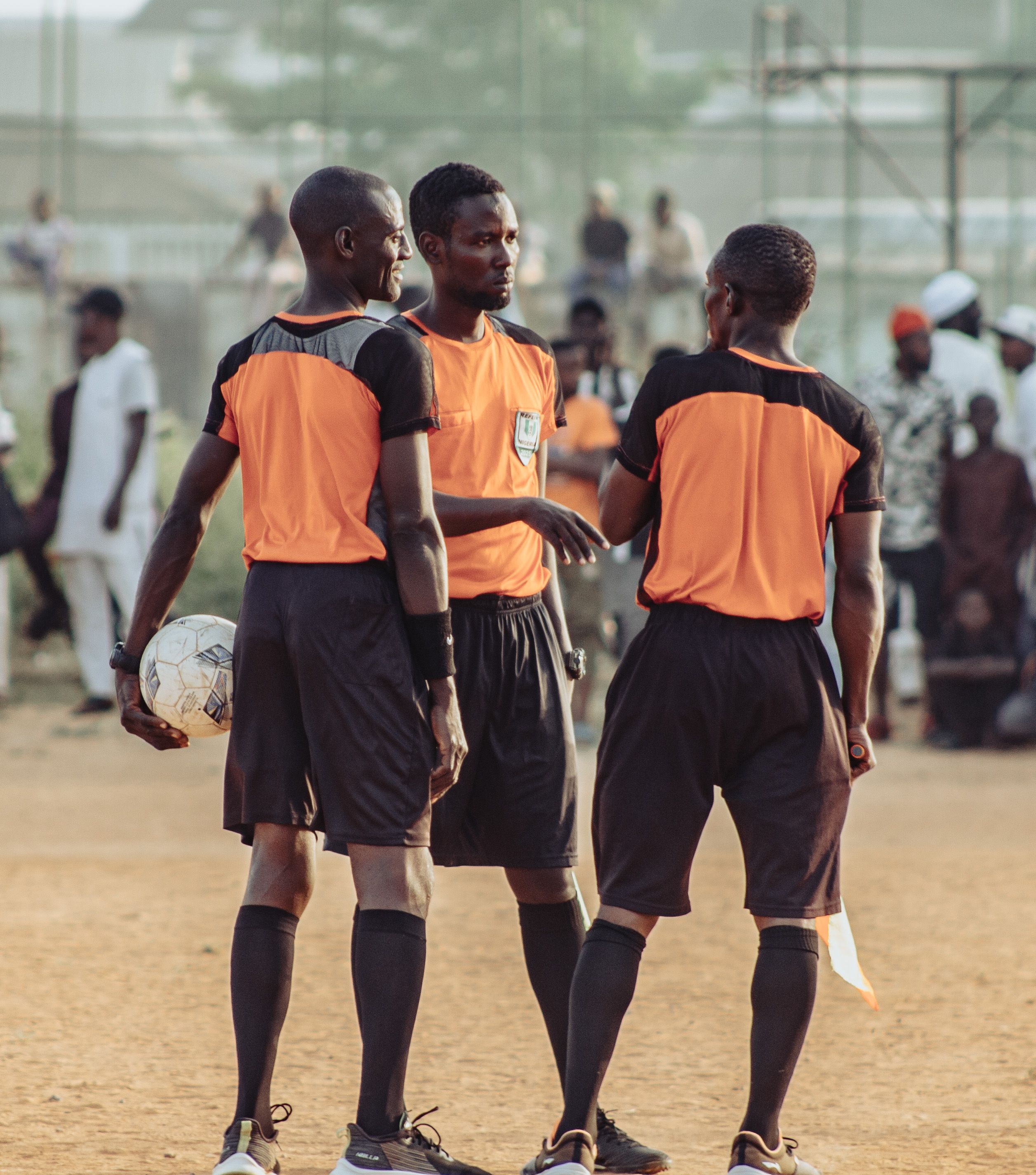 Soccer Referees Gather on Football Field · Free Stock Photo