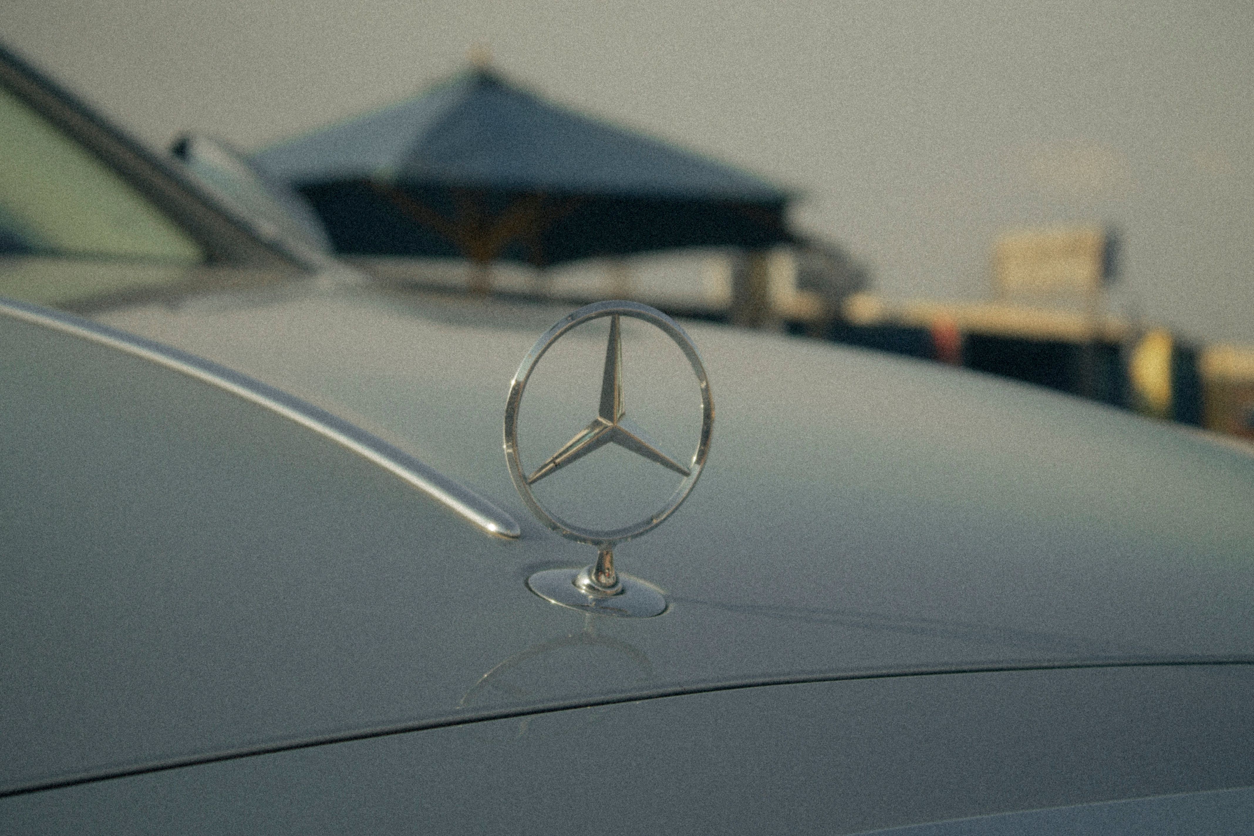 Close-up of Luxury Car Emblem Outdoors · Free Stock Photo