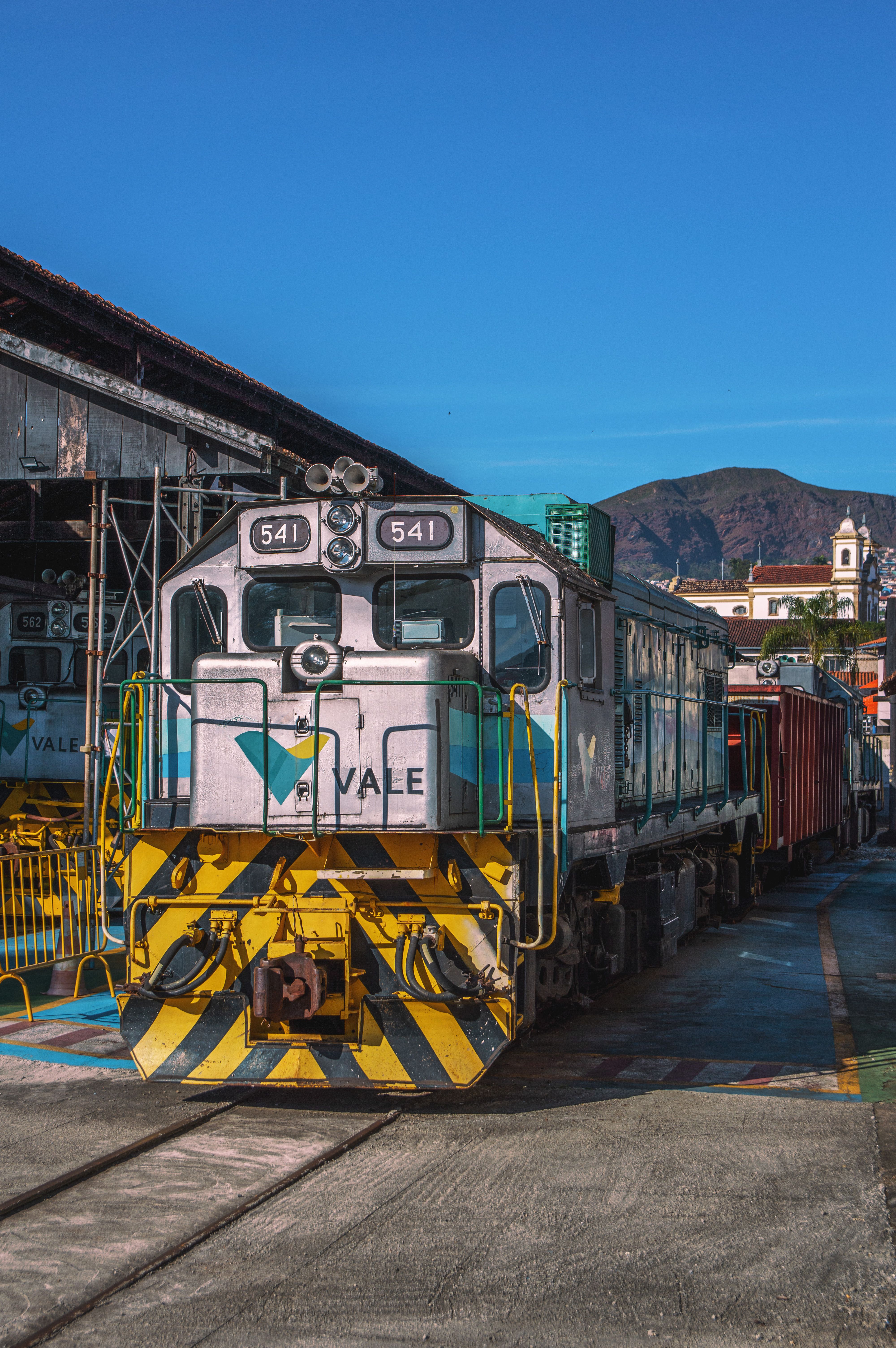 Colorful Train in Sunny Outdoor Trainyard · Free Stock Photo