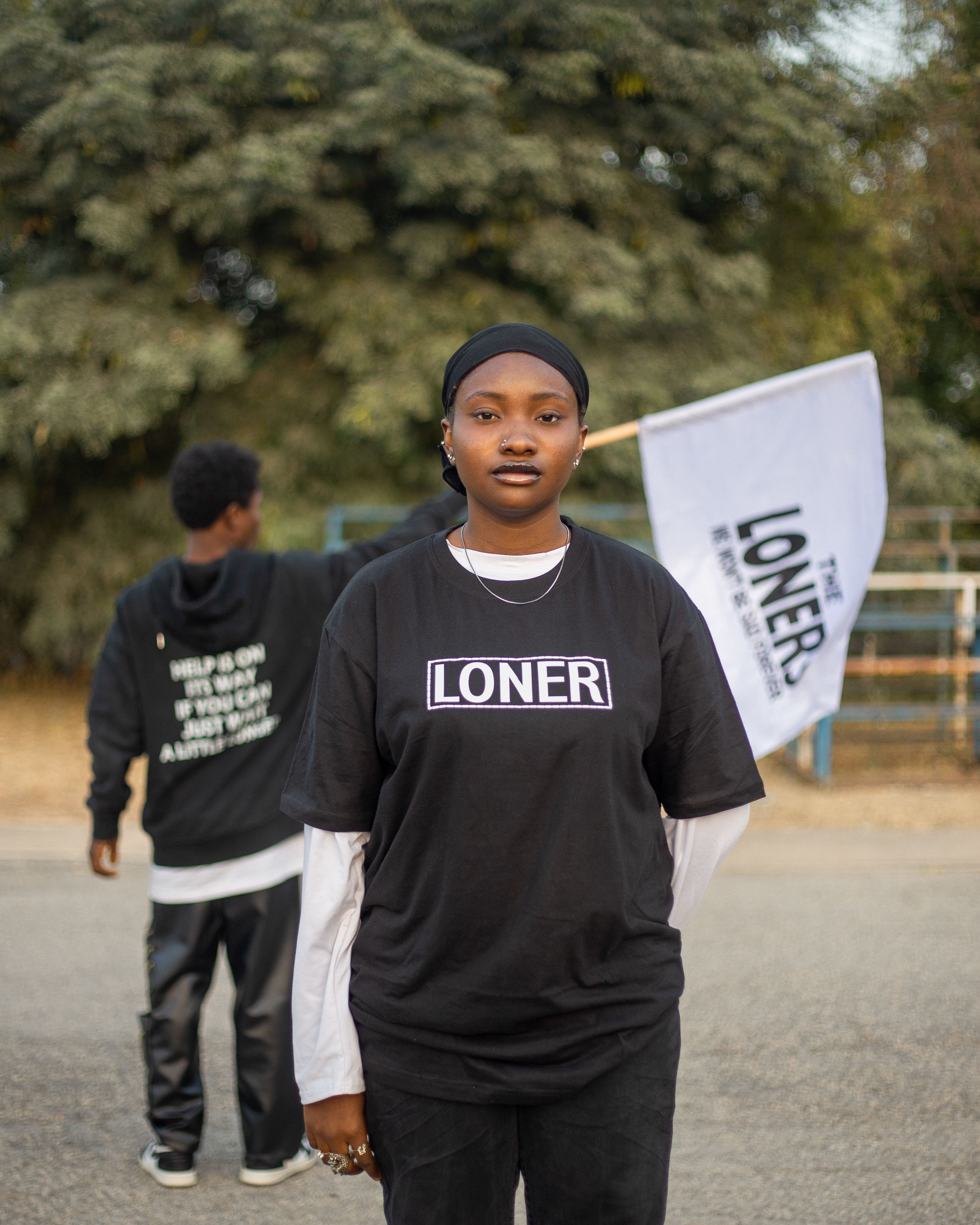 Young Protester Holding a Flag Outdoors · Free Stock Photo