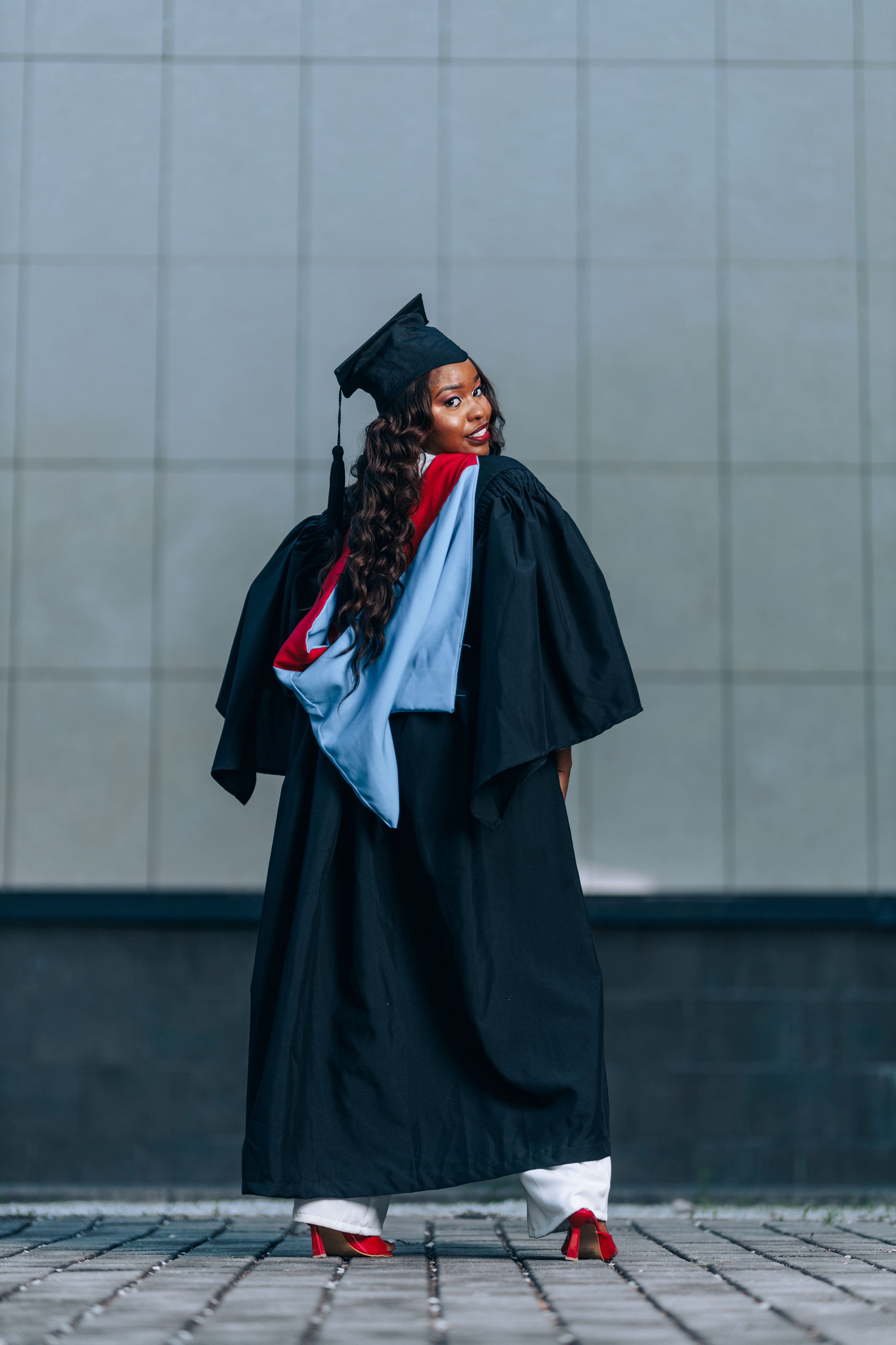 A Graduate Wearing a Mortarboard and a Graduation Gown · Free Stock Photo