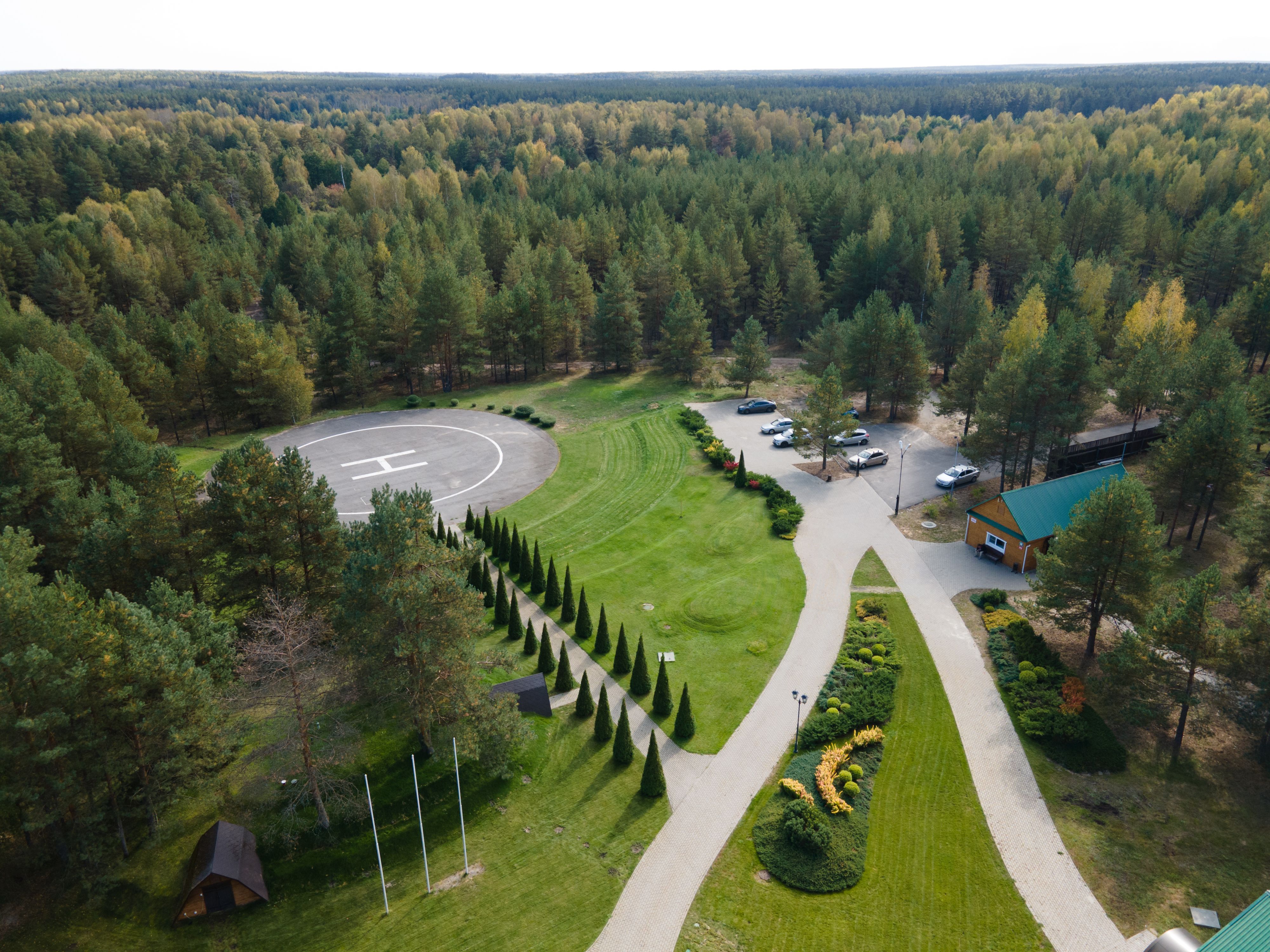 Aerial View of Forest and Helipad with Parking · Free Stock Photo