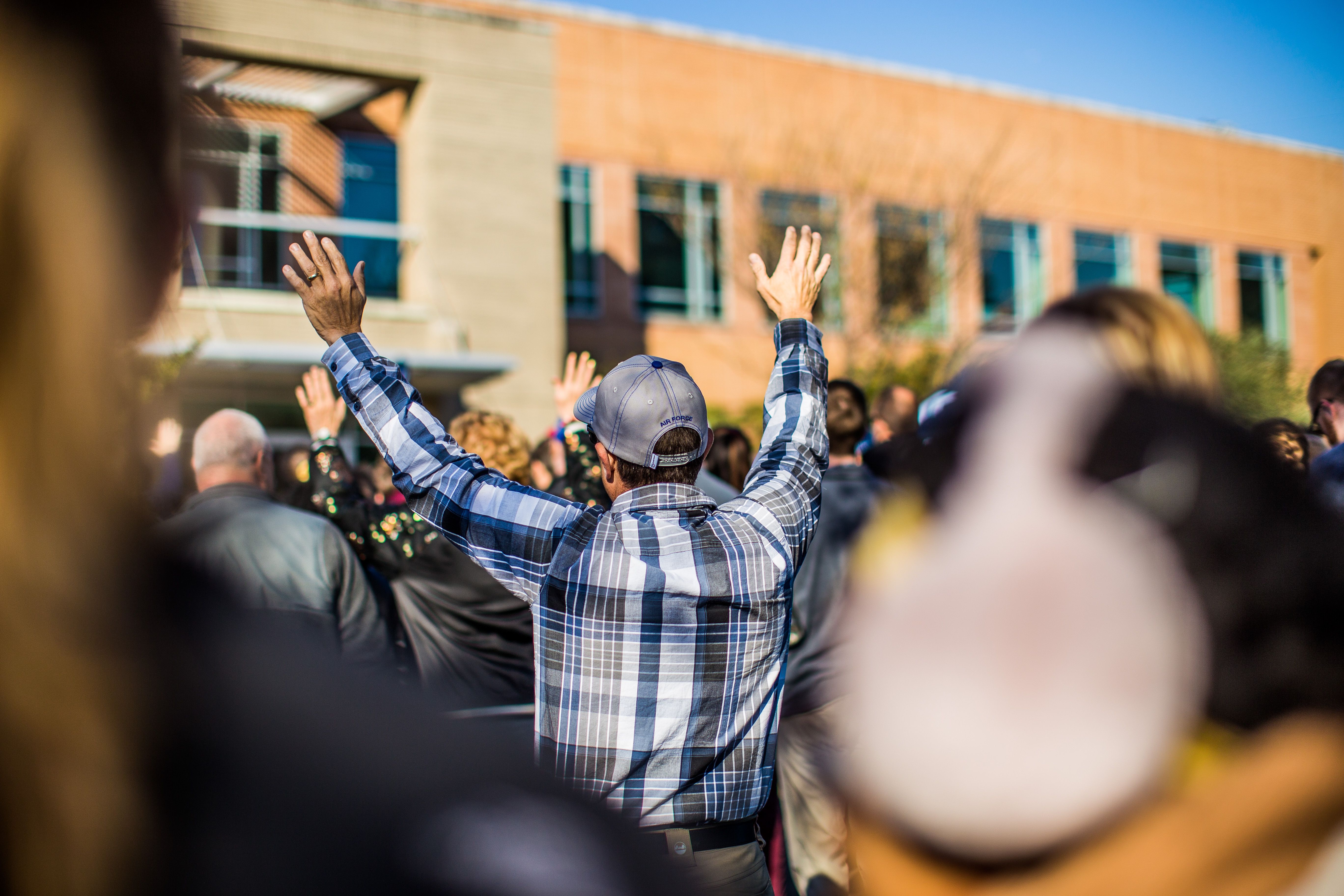 Crowd Gathering with Raised Hands Outdoors · Free Stock Photo