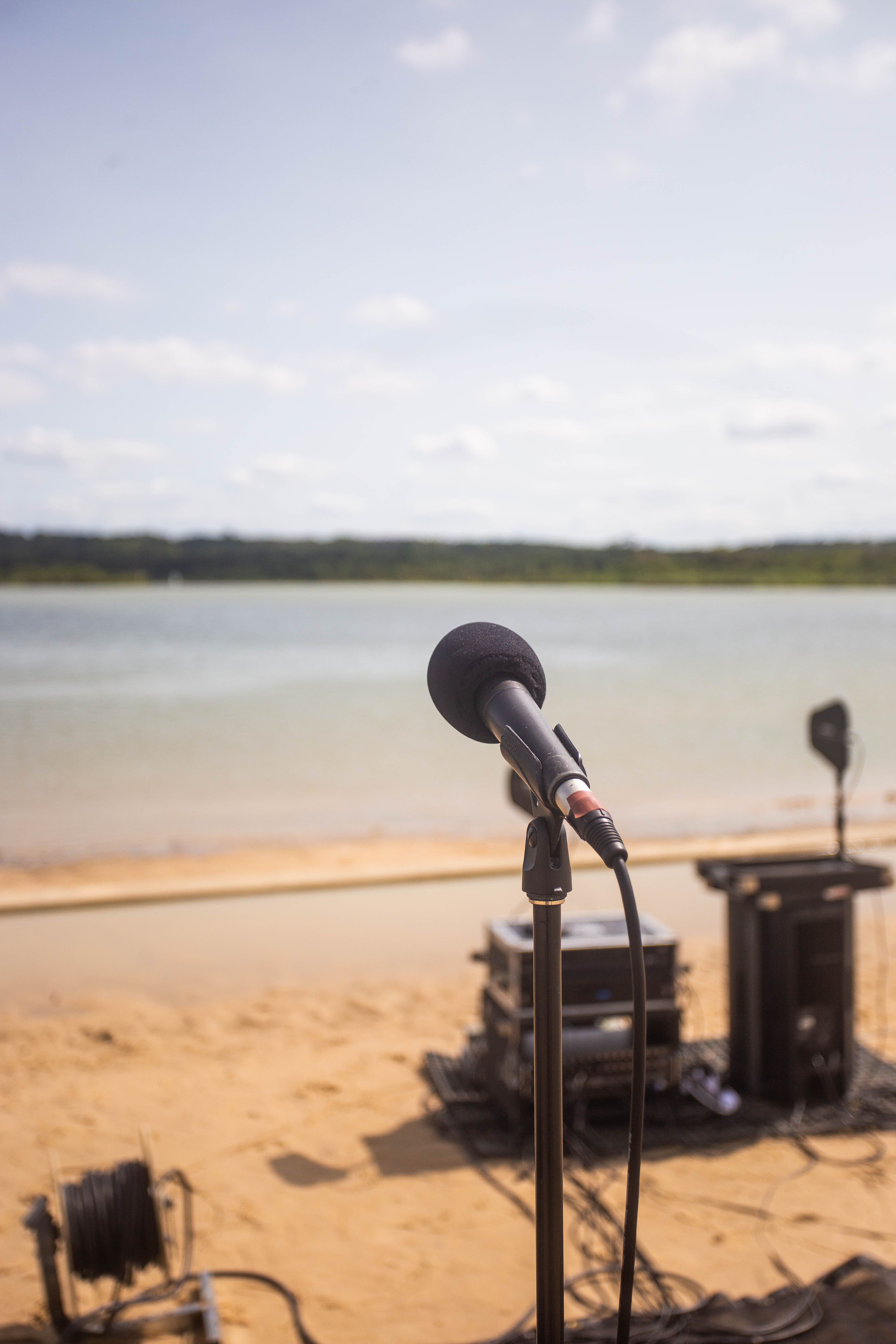 Microphone Setup on Sunny Beach Stage · Free Stock Photo