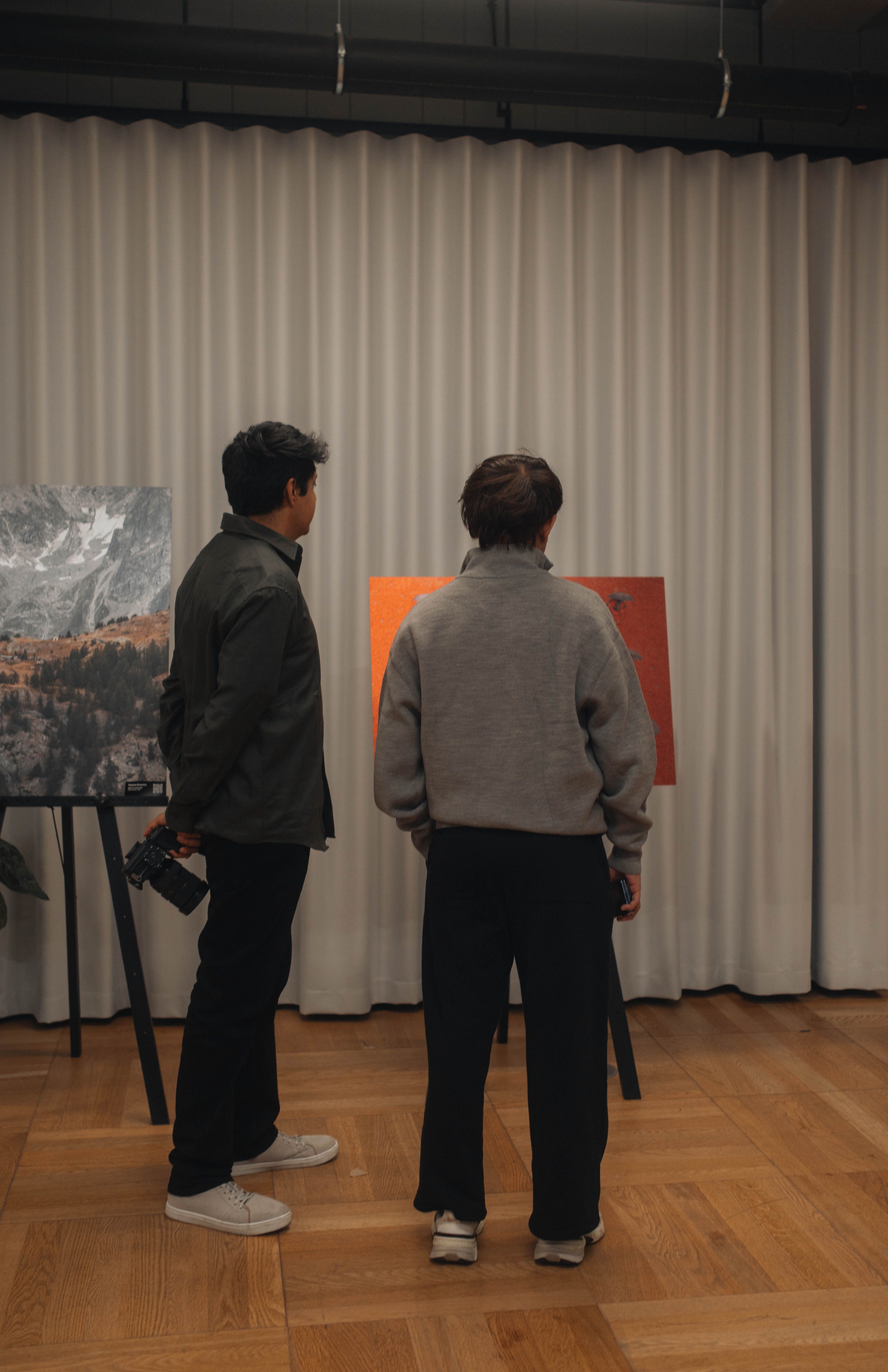 Two People Observing Art in Gallery Setting · Free Stock Photo