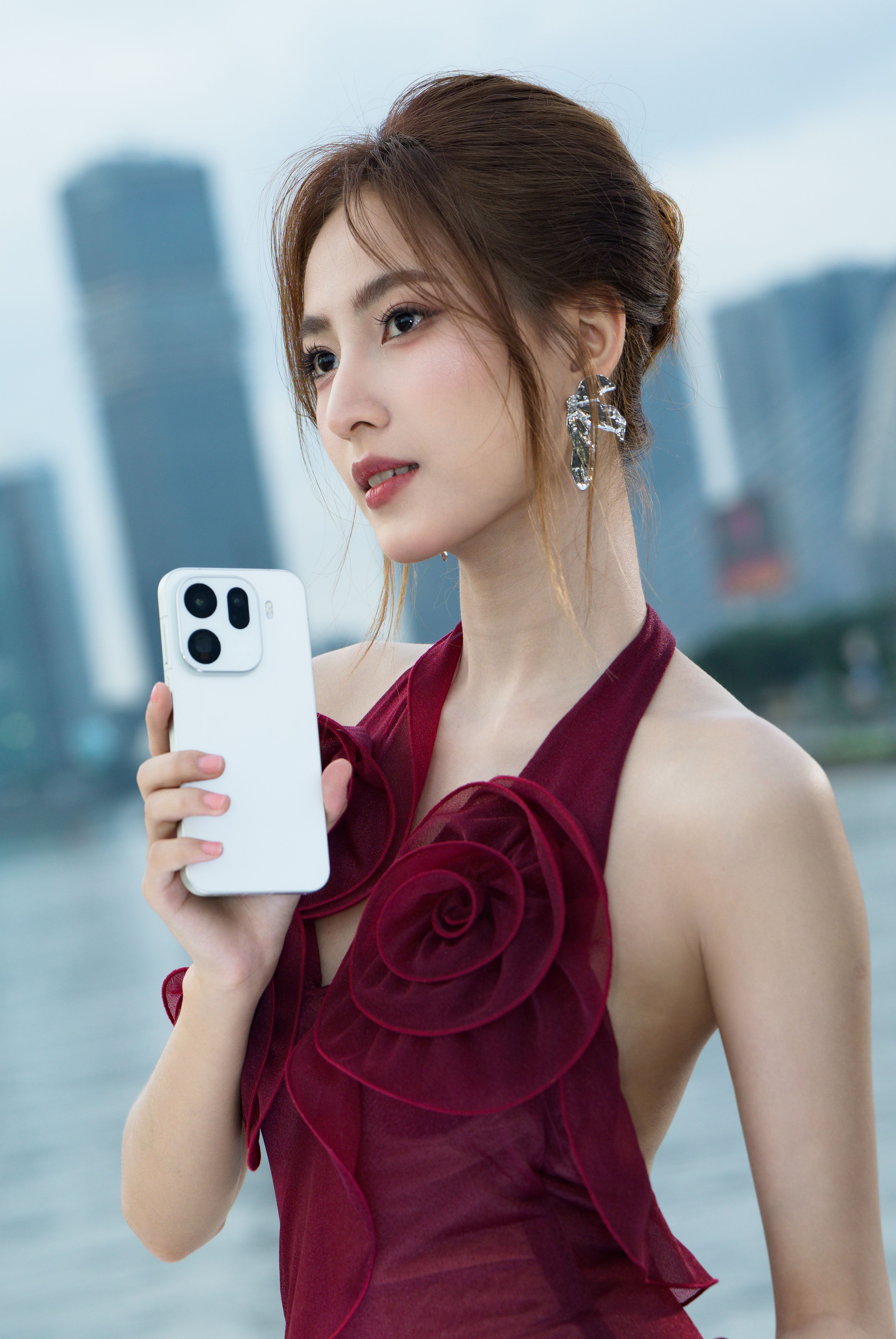 Stylish Woman Posing with Smartphone Outdoors · Free Stock Photo