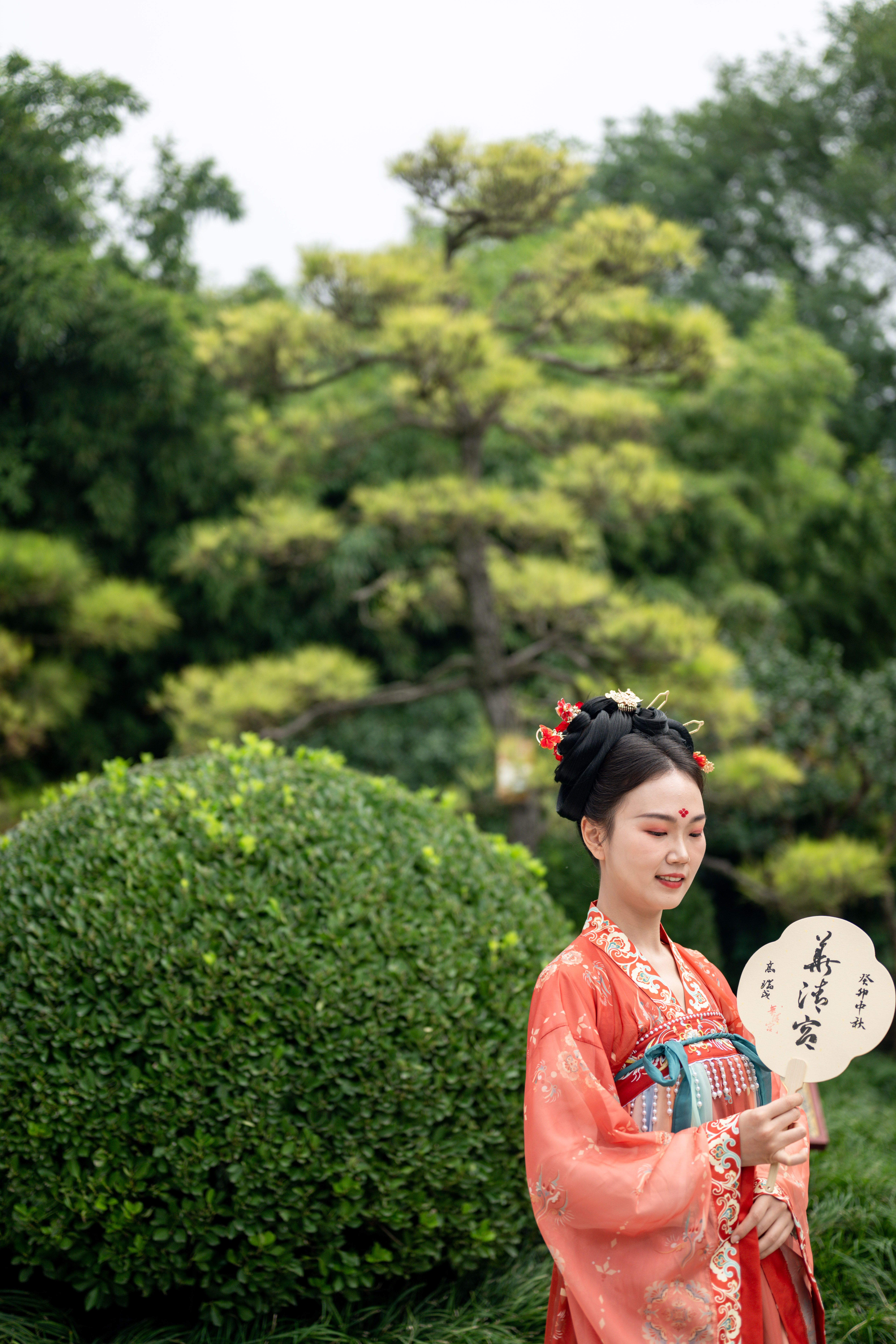 Young Woman in Traditional Hanfu with Fan Outdoors · Free Stock Photo