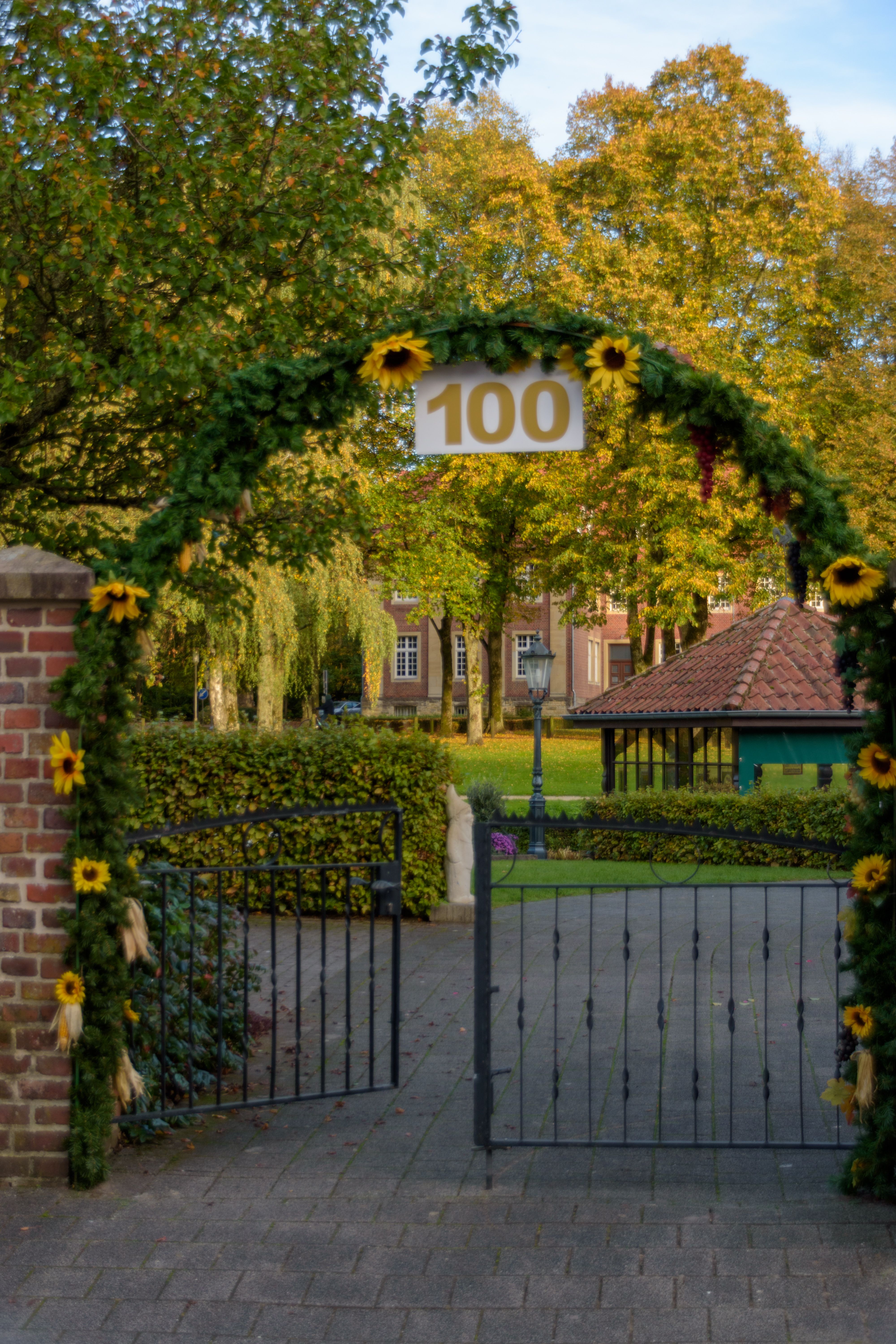 Arched Garden Entrance Decorated with Sunflowers · Free Stock Photo