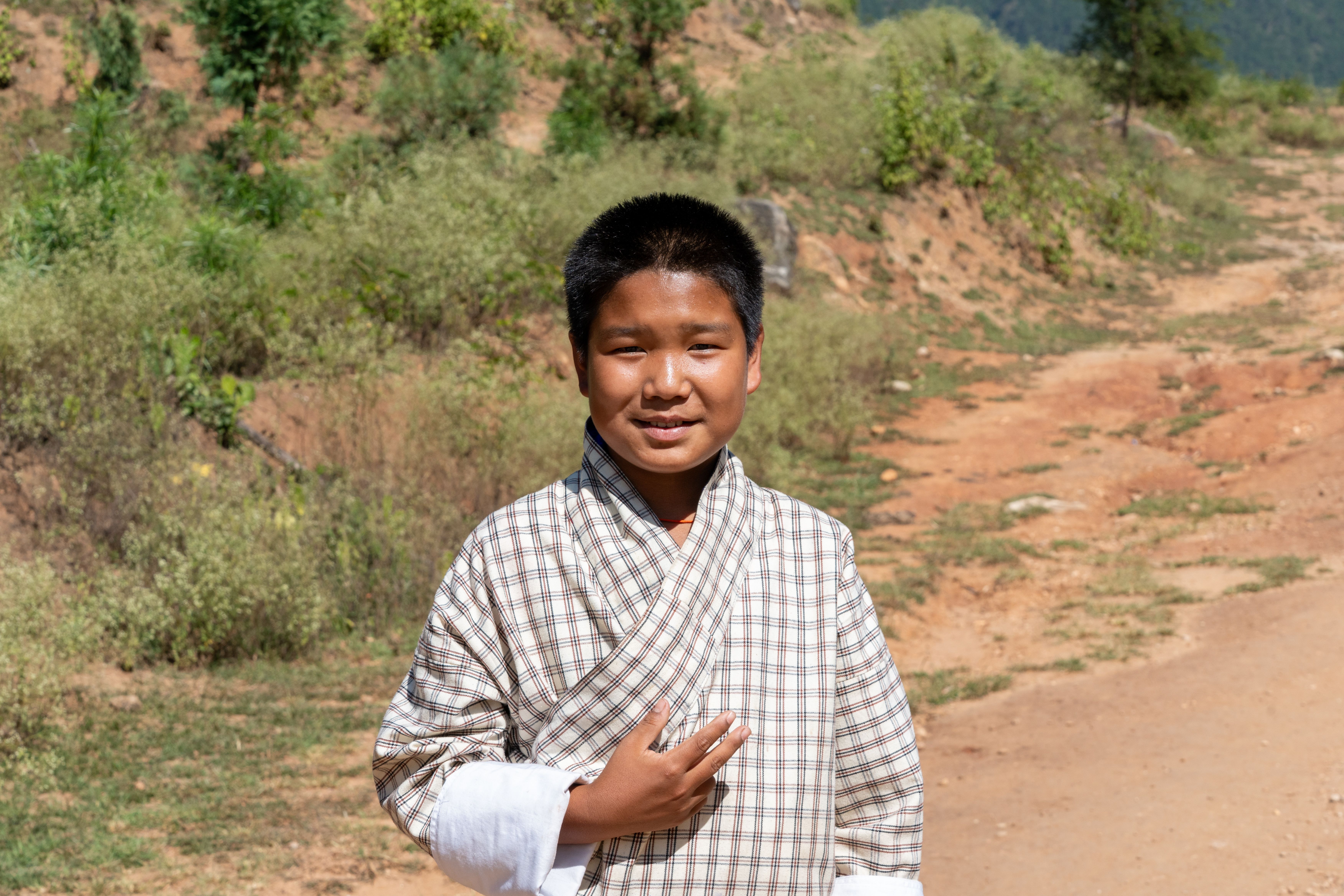 Young Boy in Traditional Garb Smiling Outdoors · Free Stock Photo