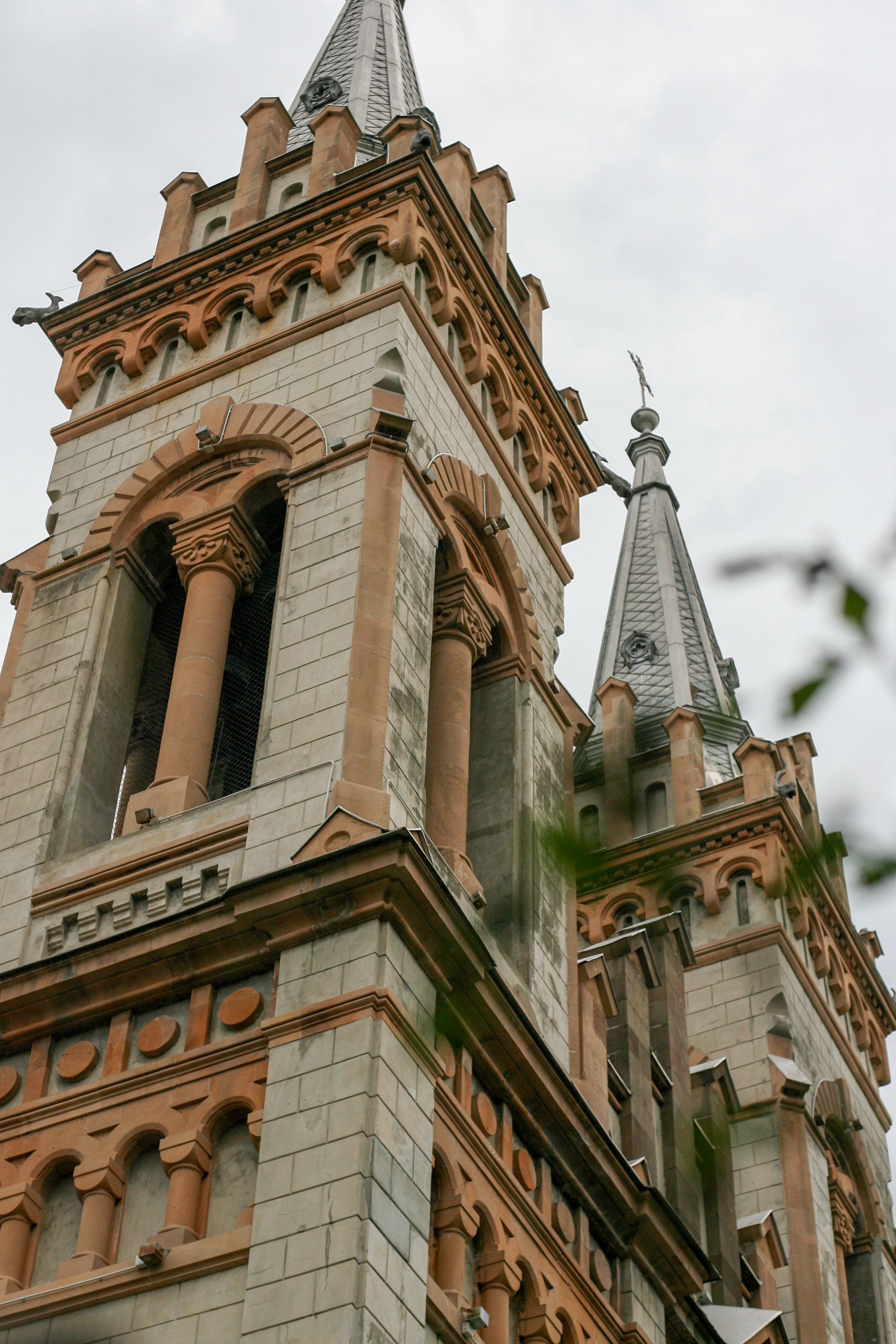 Gothic Revival Church Towers Against Cloudy Sky · Free Stock Photo
