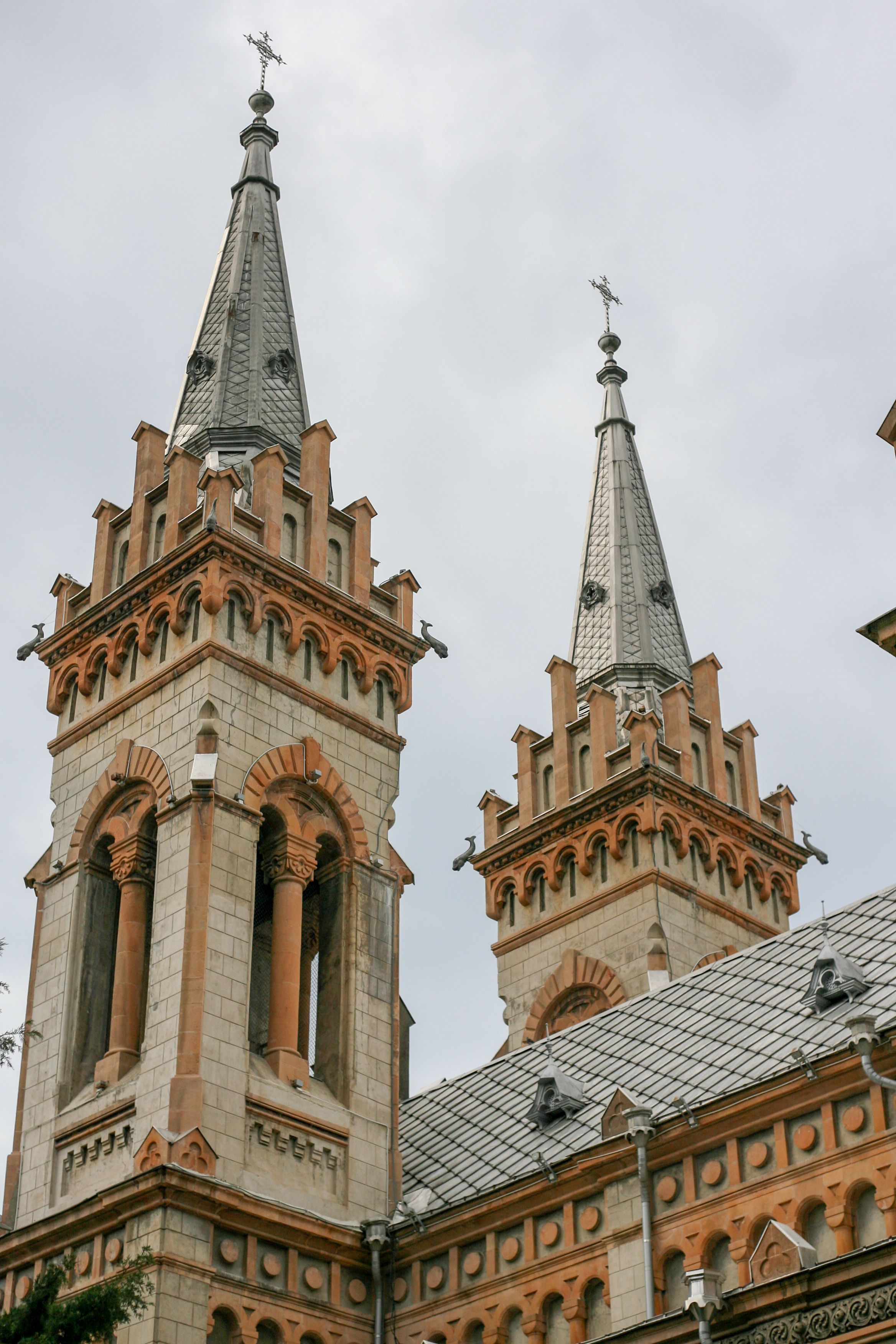 Gothic Revival Church Towers Against Cloudy Sky · Free Stock Photo
