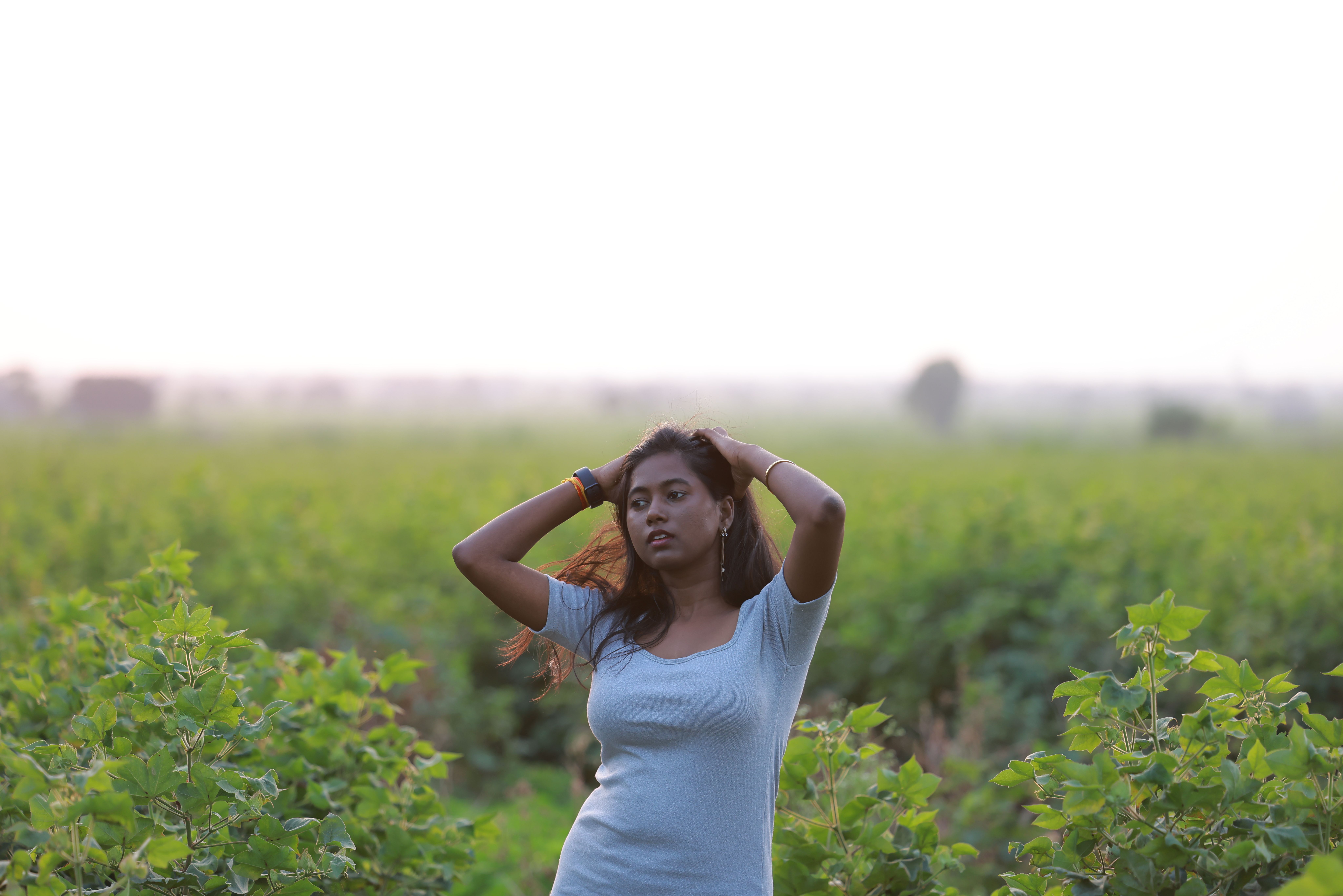 Young Woman Posing in Lush Green Farm Field · Free Stock Photo