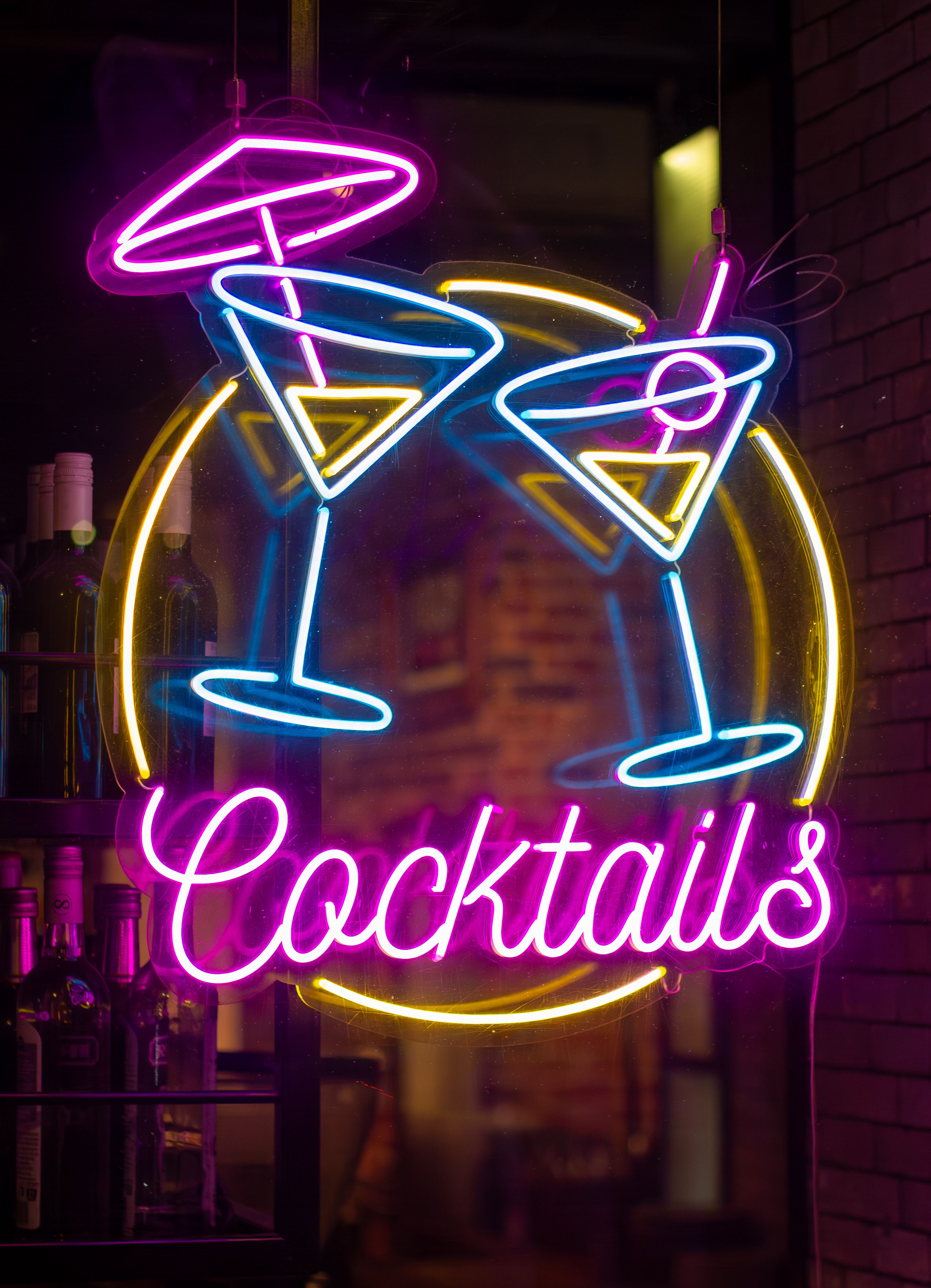Vibrant Neon Cocktail Sign in Bar Setting · Free Stock Photo