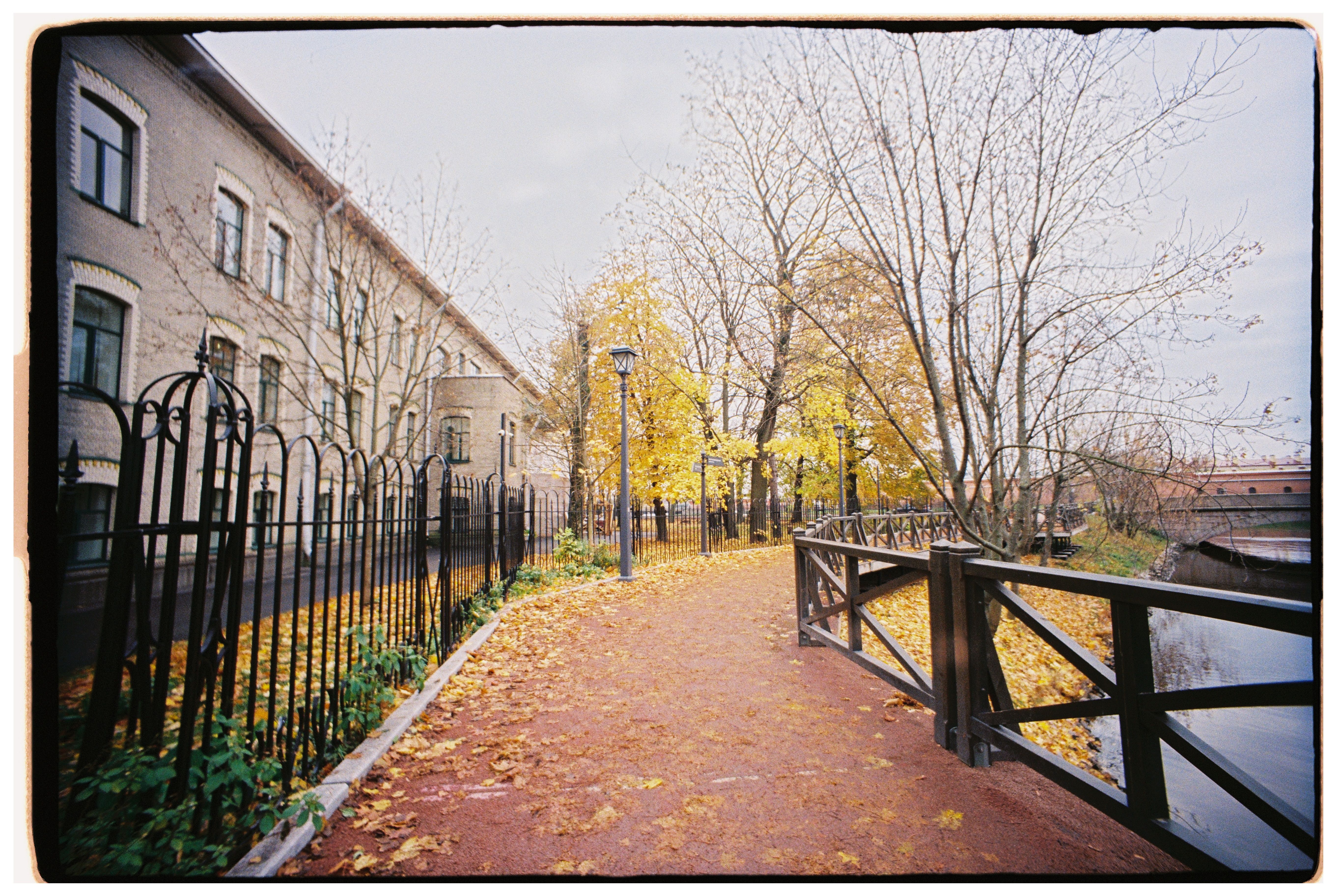 Charming Autumn Pathway Along City Canal · Free Stock Photo