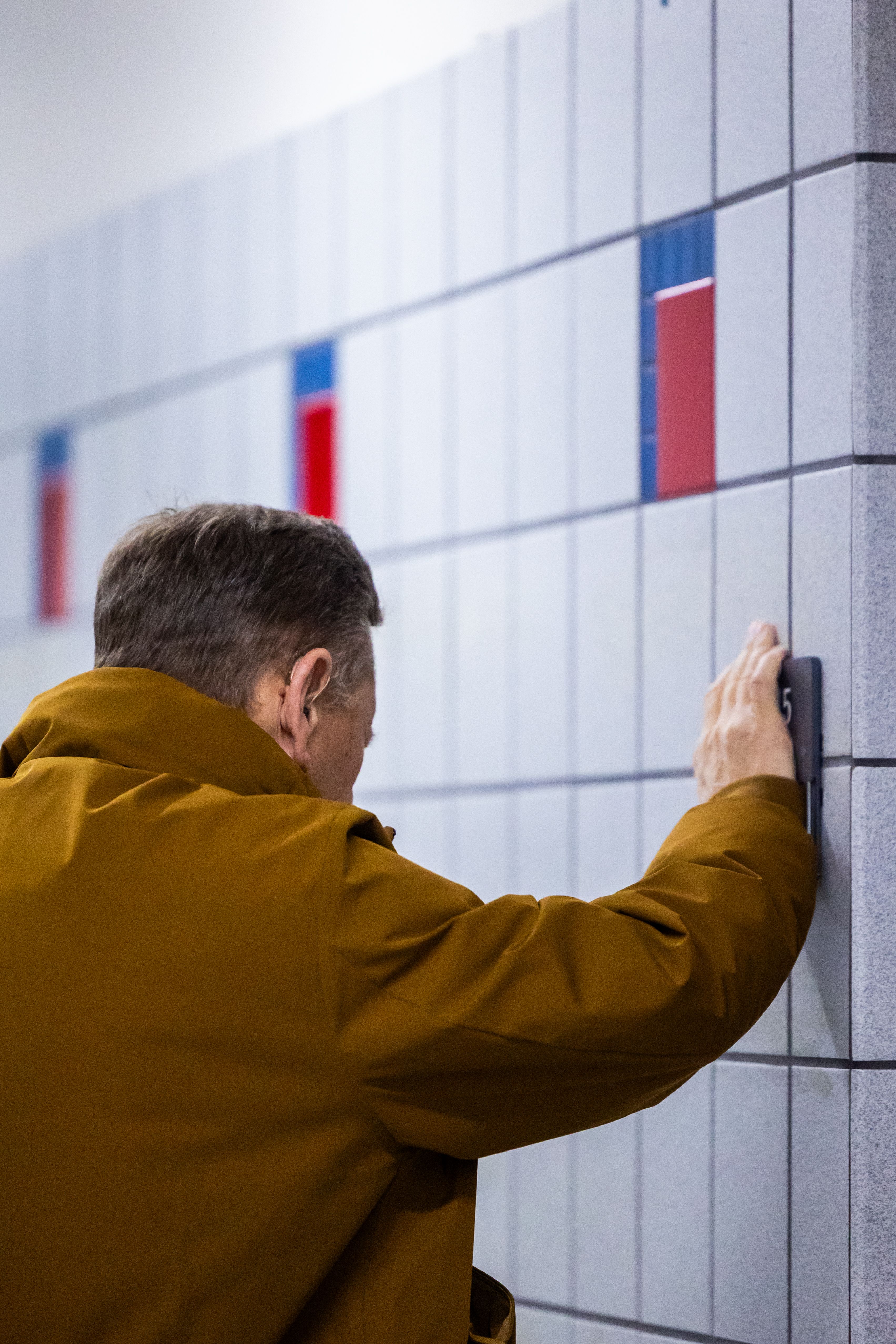 Person Touching Tiled Wall in Interior Space · Free Stock Photo